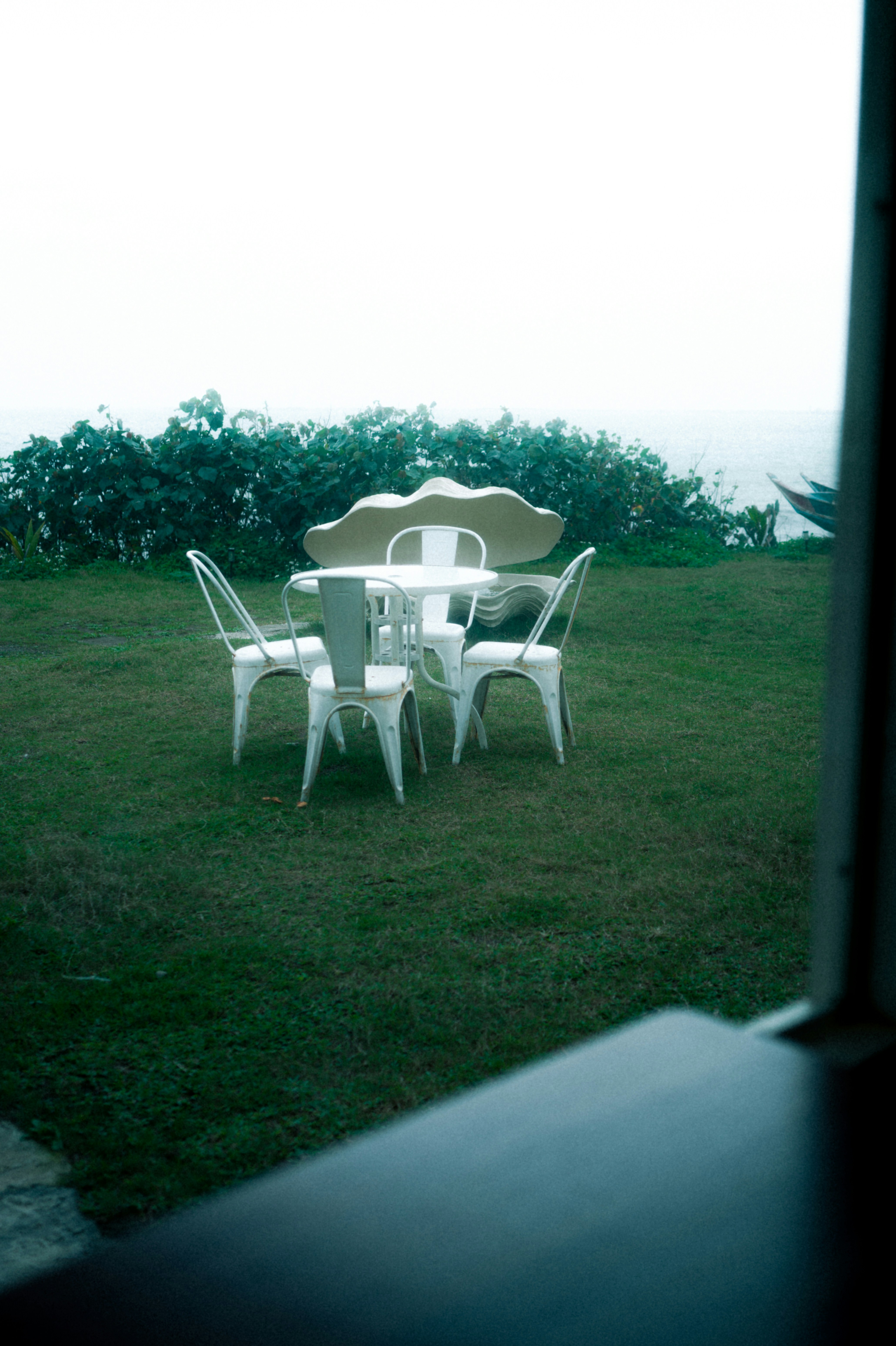 Cozy coastal patio set framed by sea fog