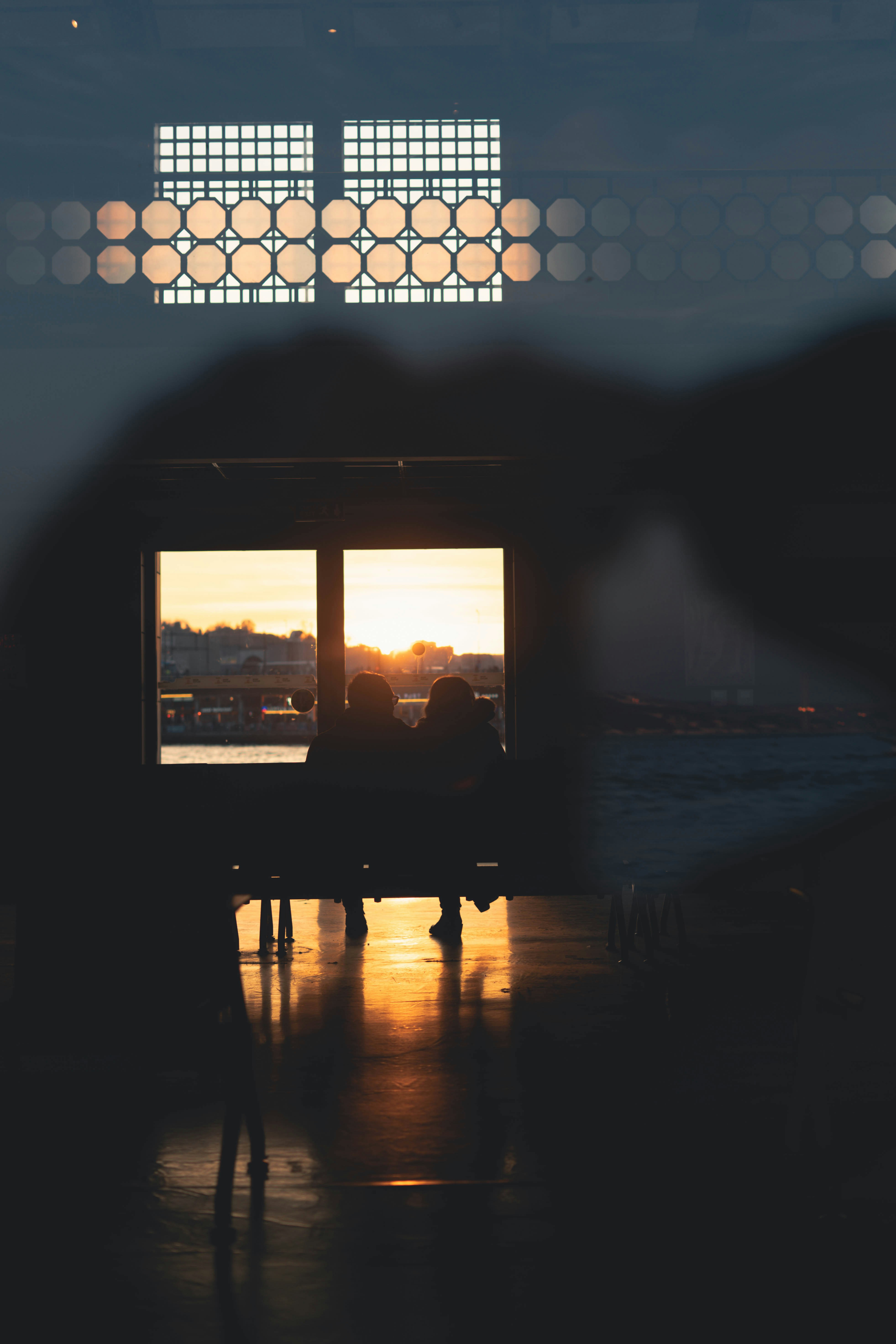 Sunset through a silhouette: a quiet window into a harbor scene