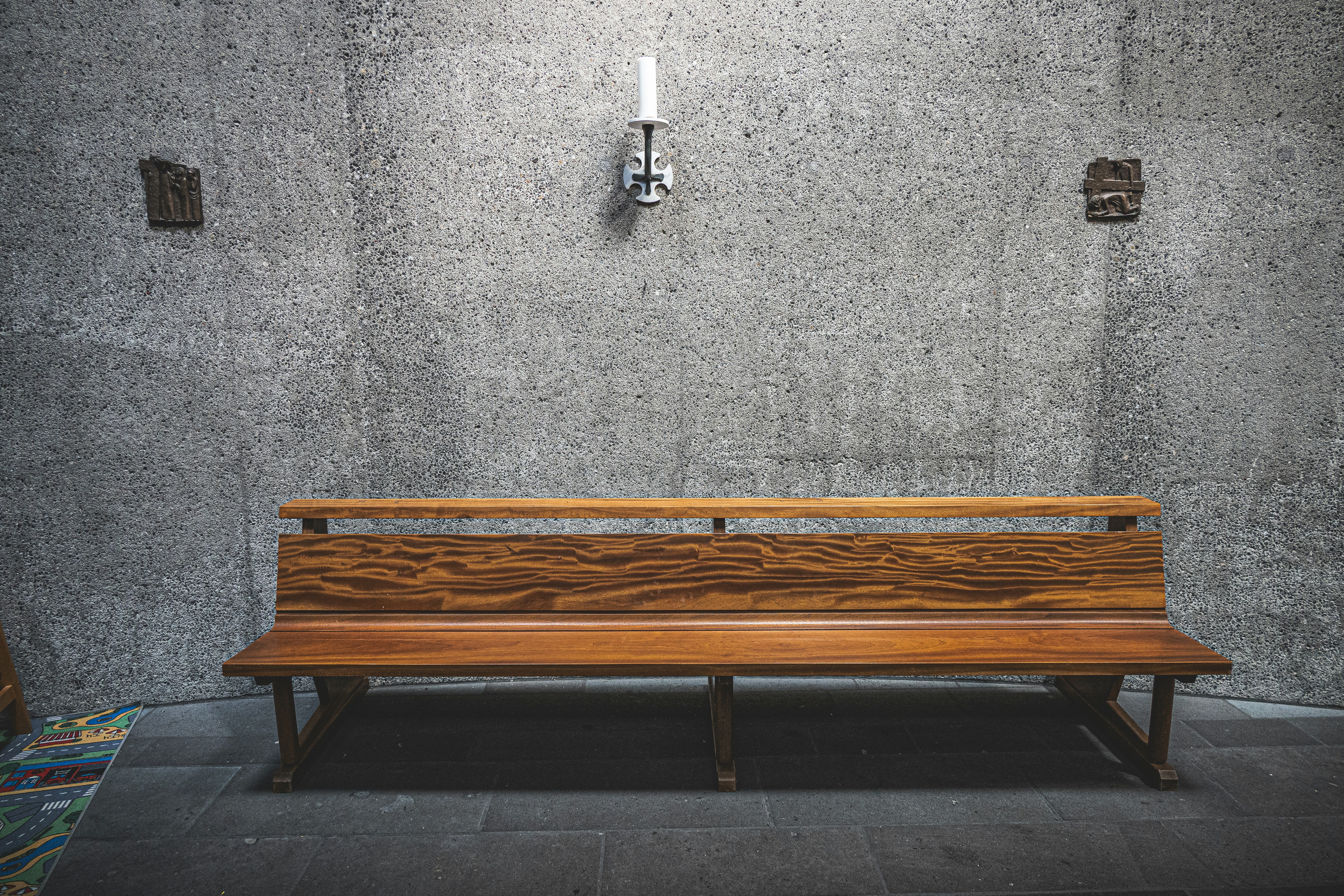 A Silent Bench Under a Stone Wall