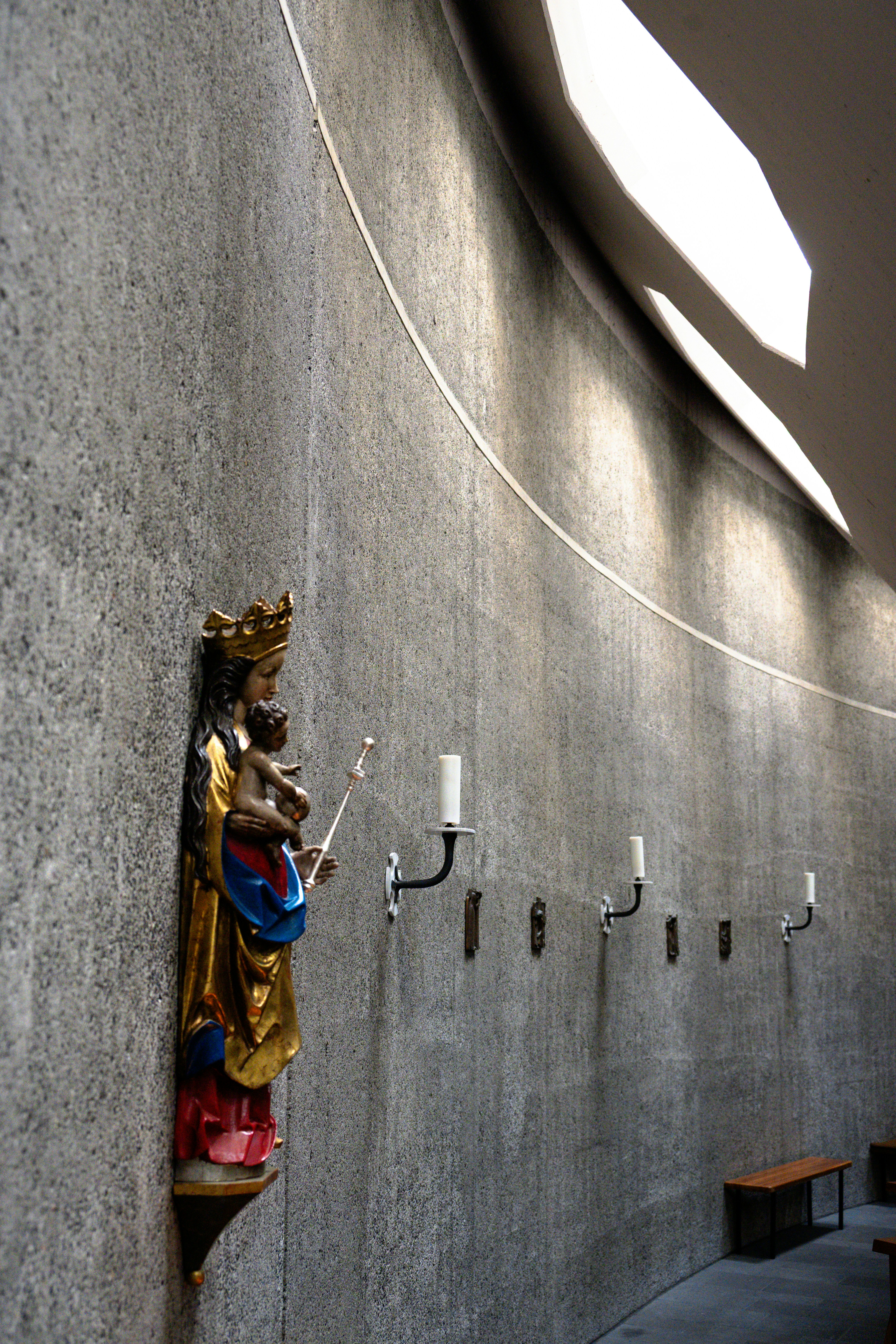 Icon in the Hall: A Statue Keeper Beside Quiet Candles
