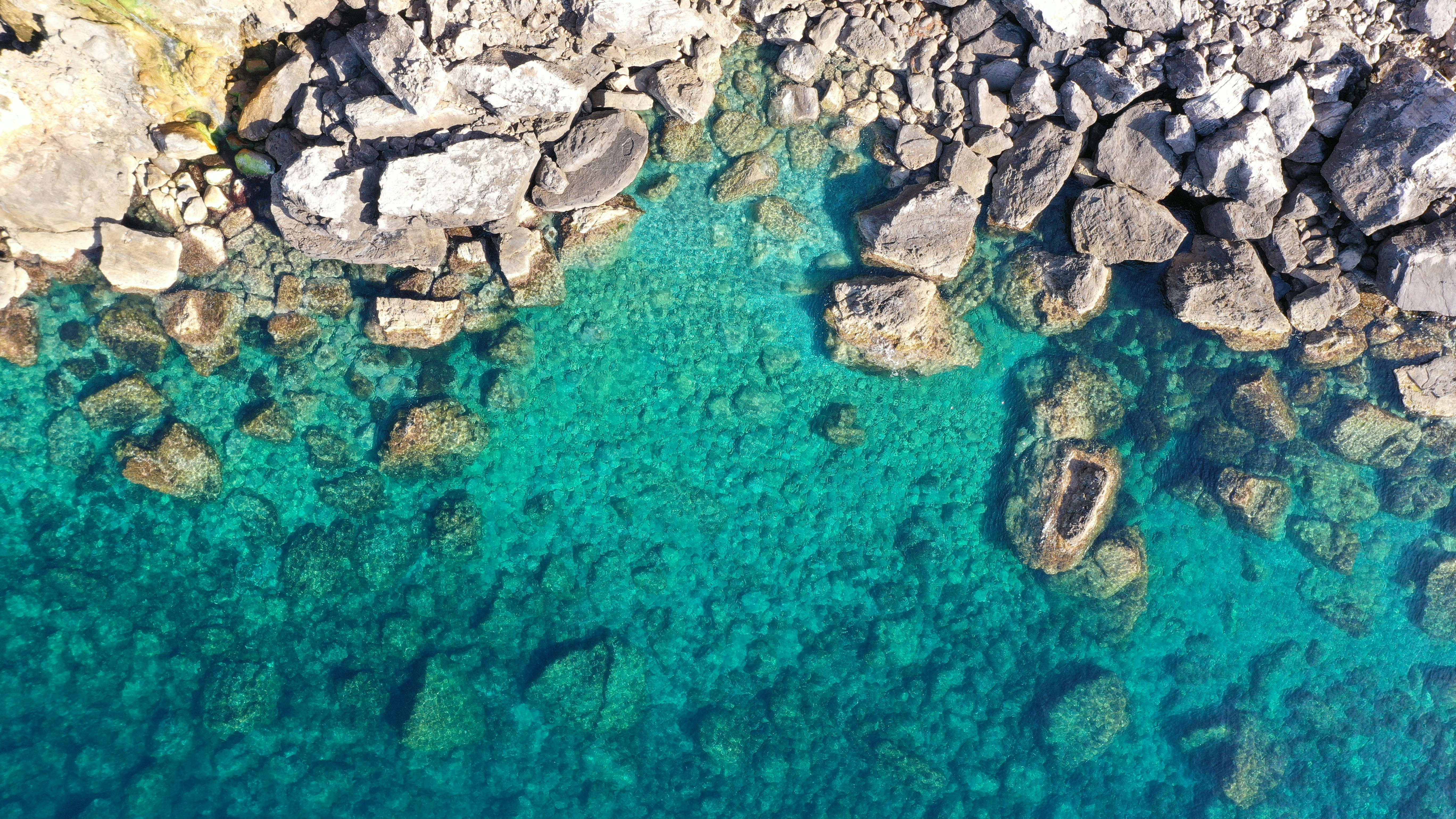 Aerial Prism: Turquoise Waters Between Rugged Shoreline