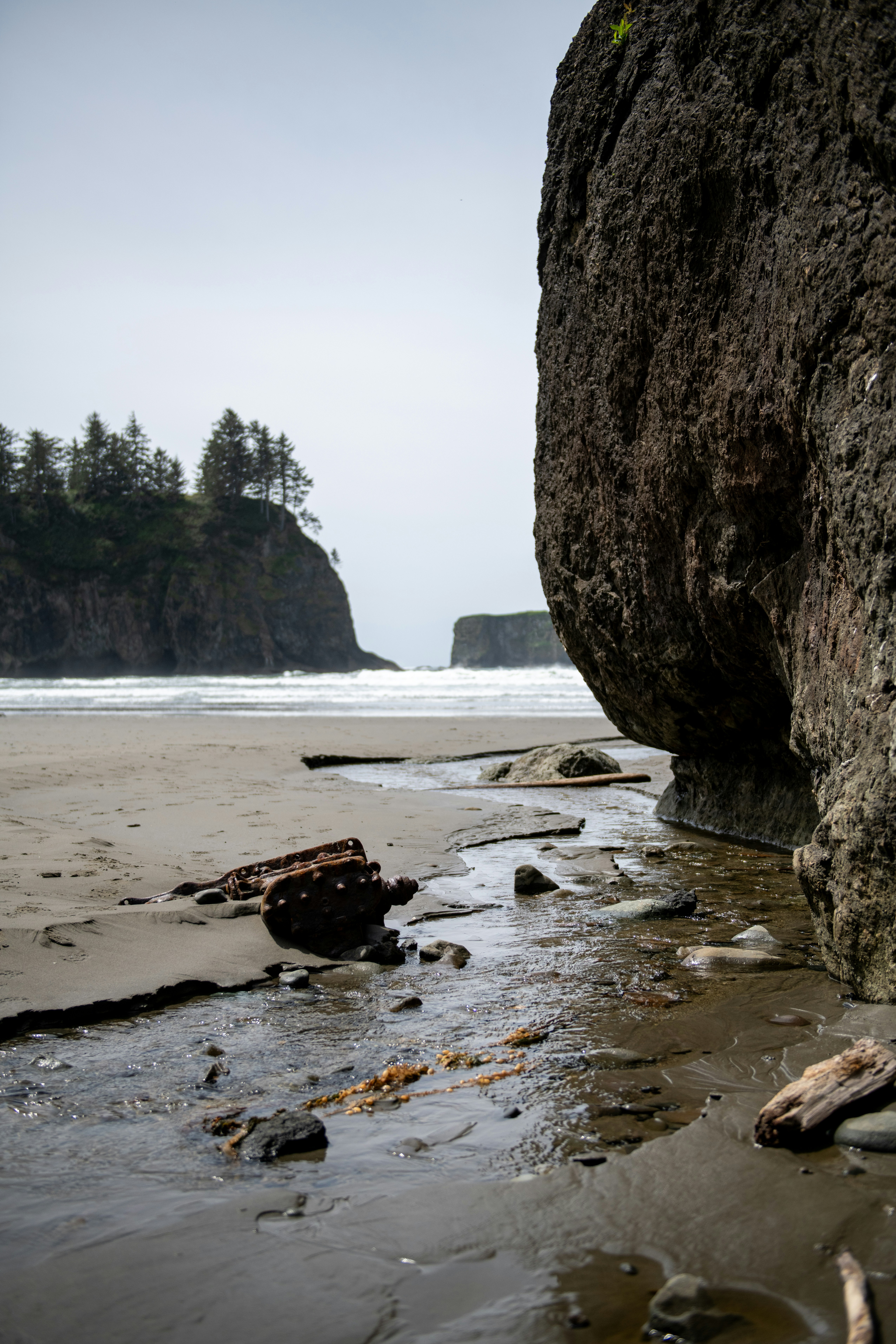 Shadowed Edge: A Quiet Beach Between Giant Rocks