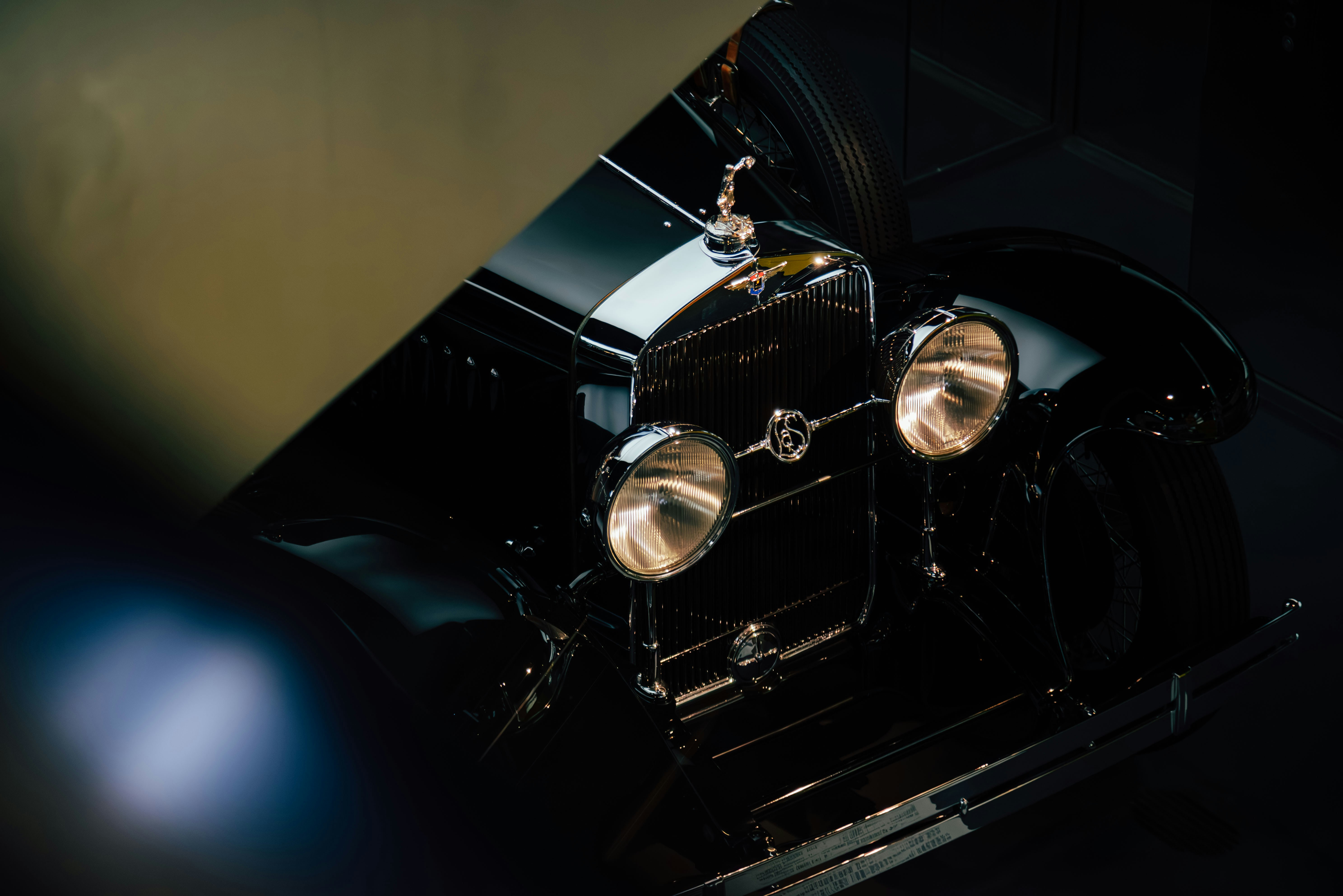 Close-up of a vintage car's front grille and headlights