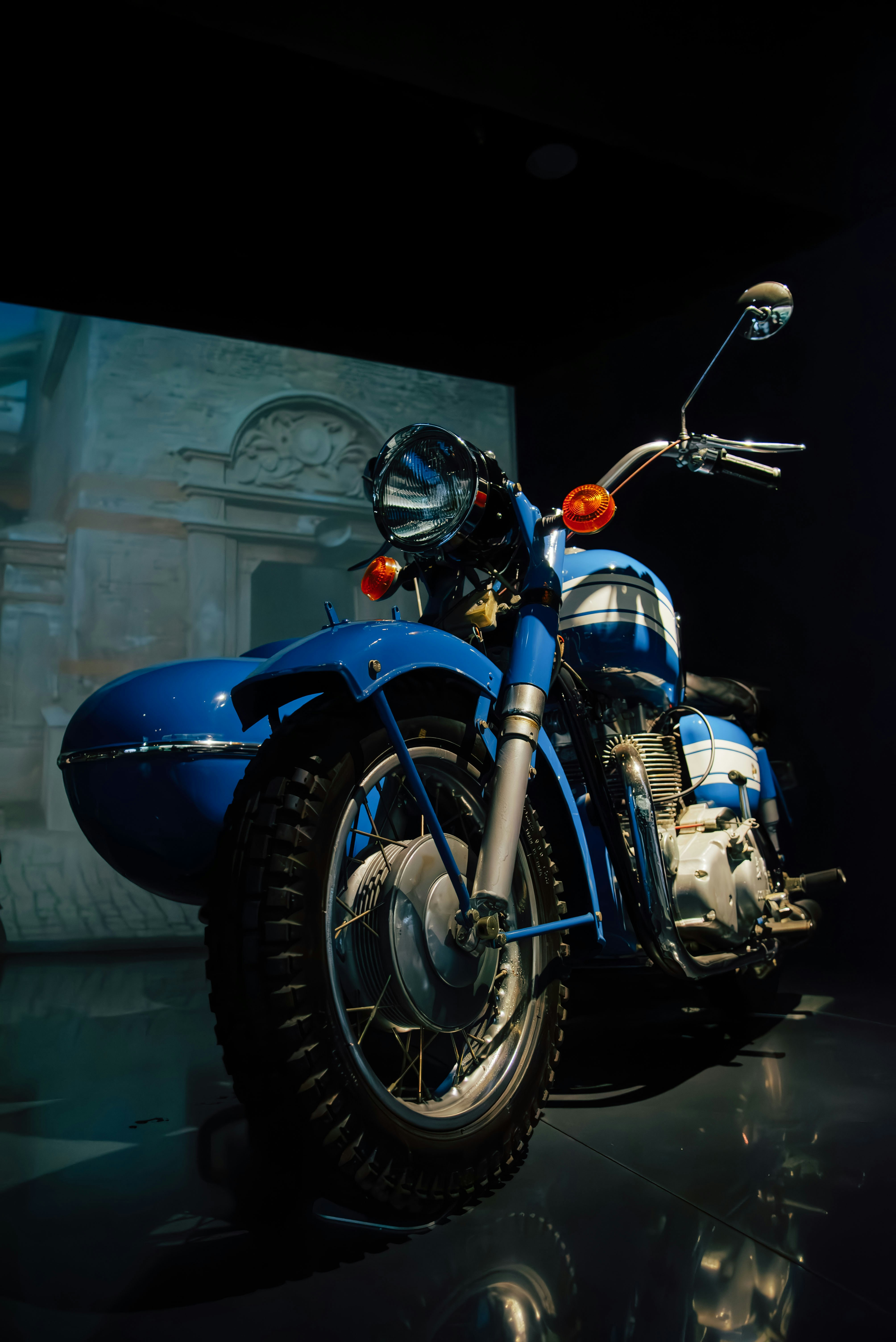 A vintage blue motorcycle with a sidecar