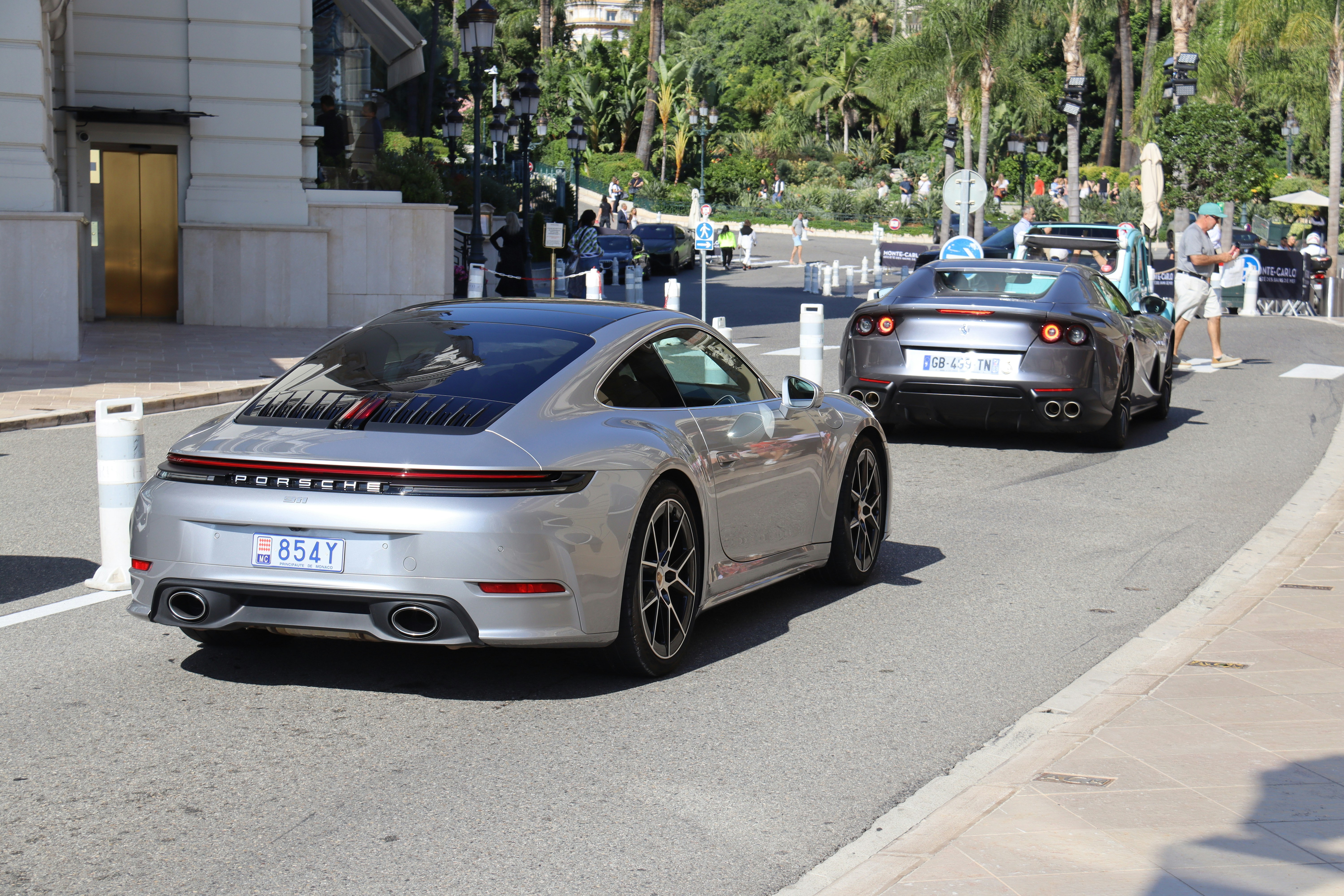 Twin Turbos on a Sunlit Street: A Porsche Parade Exits the City