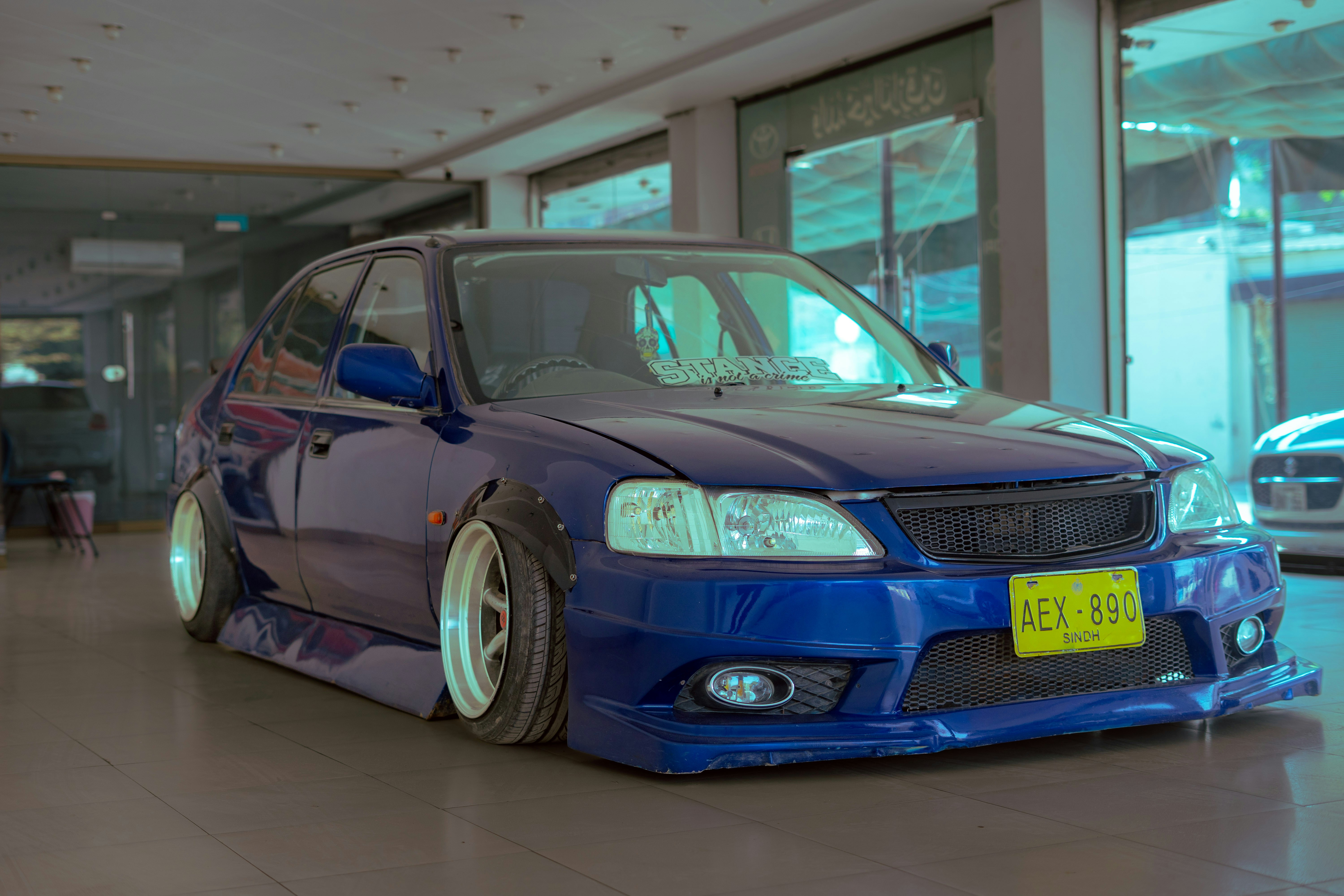 Blue Stance: Aged Rally Feel in a Modern Showroom