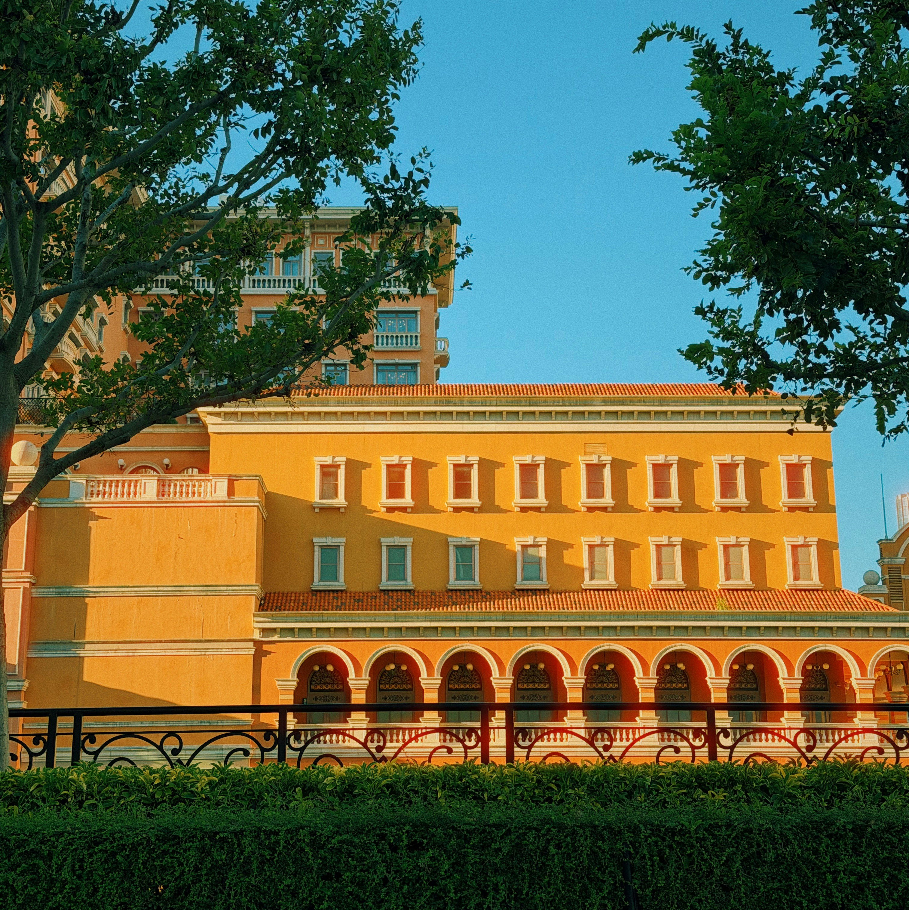 Sunlit Mission Architecture: Orange Facades and Arched Courtyard