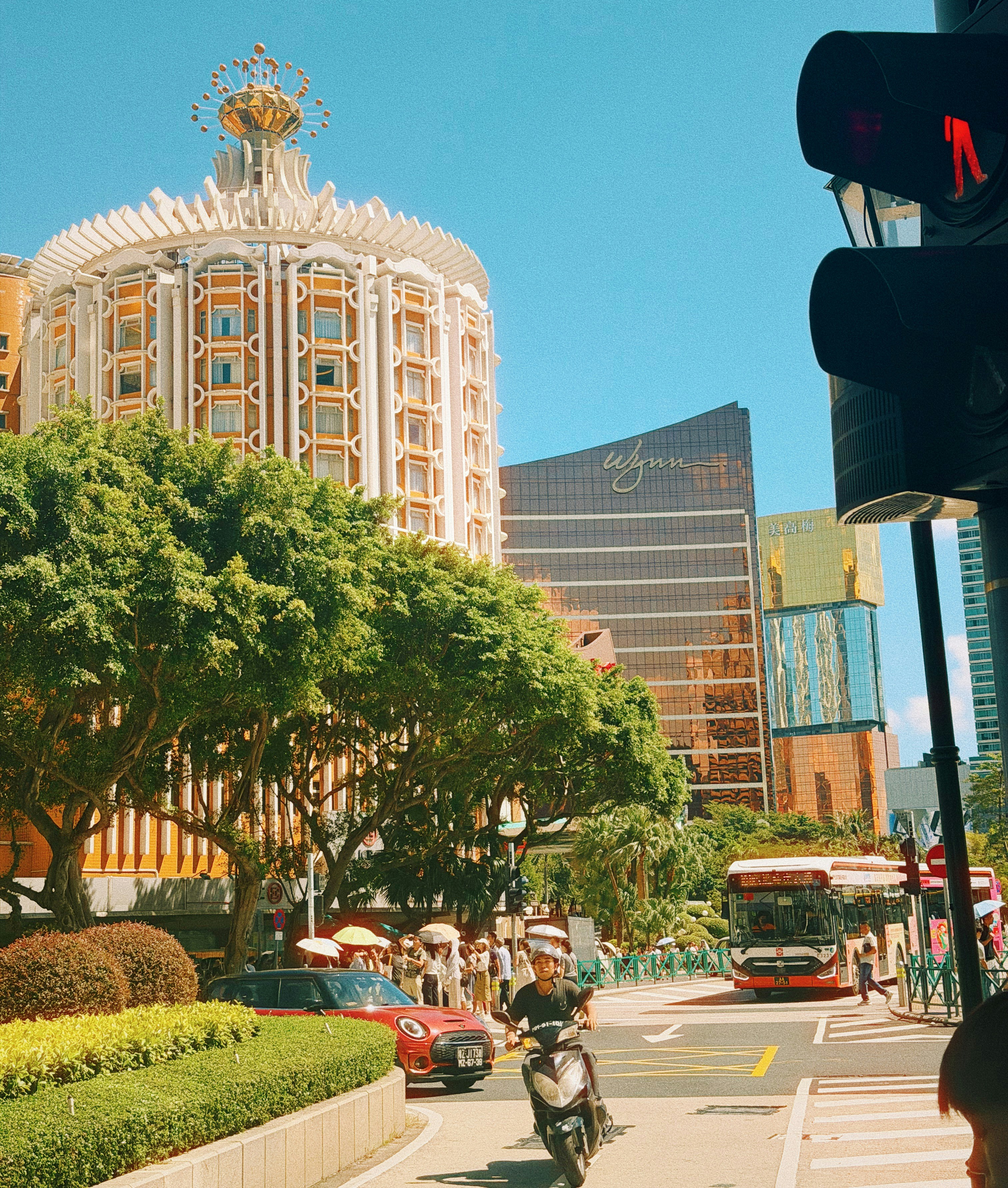 Sunlit Avenue: Urban Motion Beneath an Ornate Crown