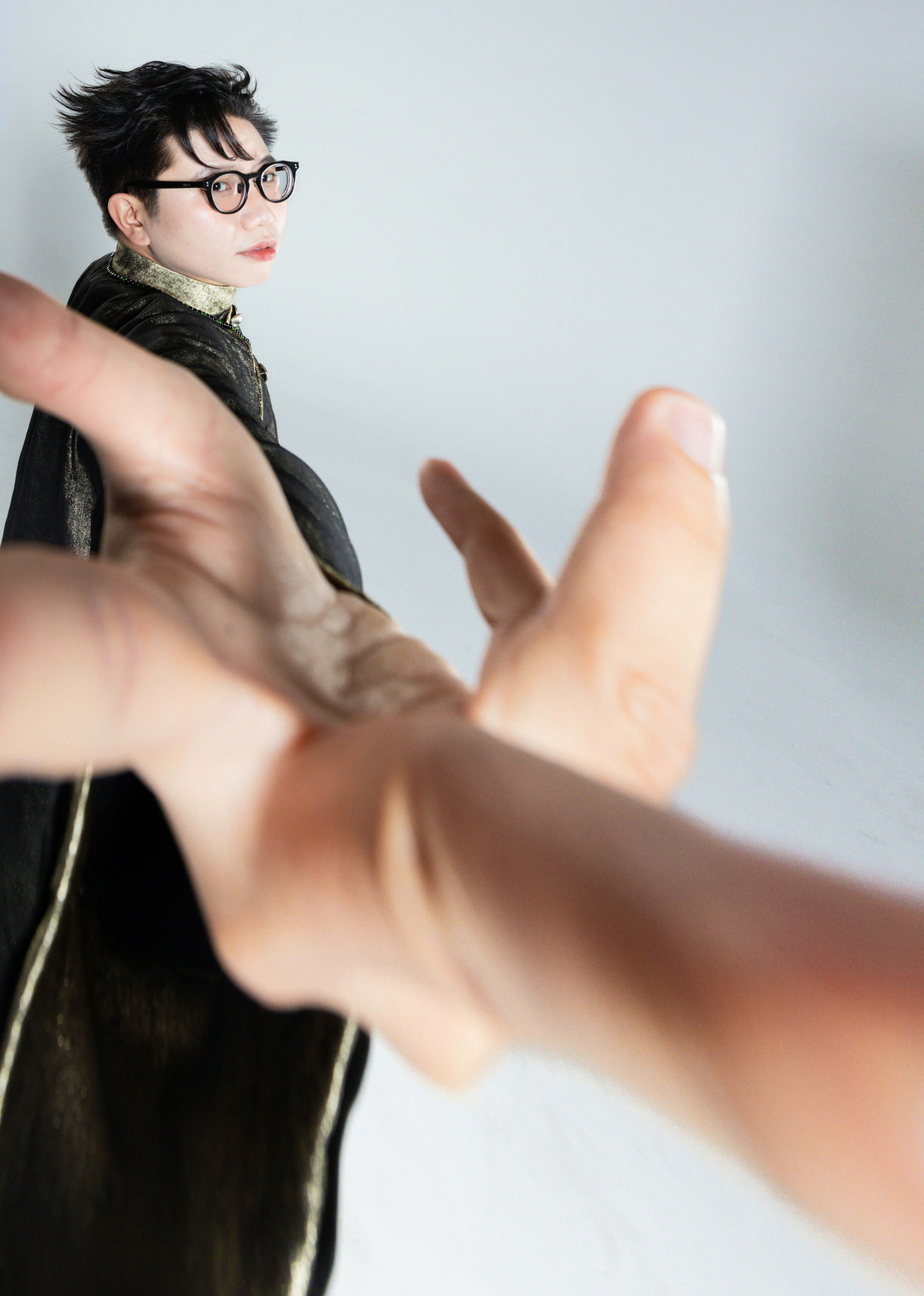 Framed in Focus: A Quiet Glance Behind a Reaching Hand