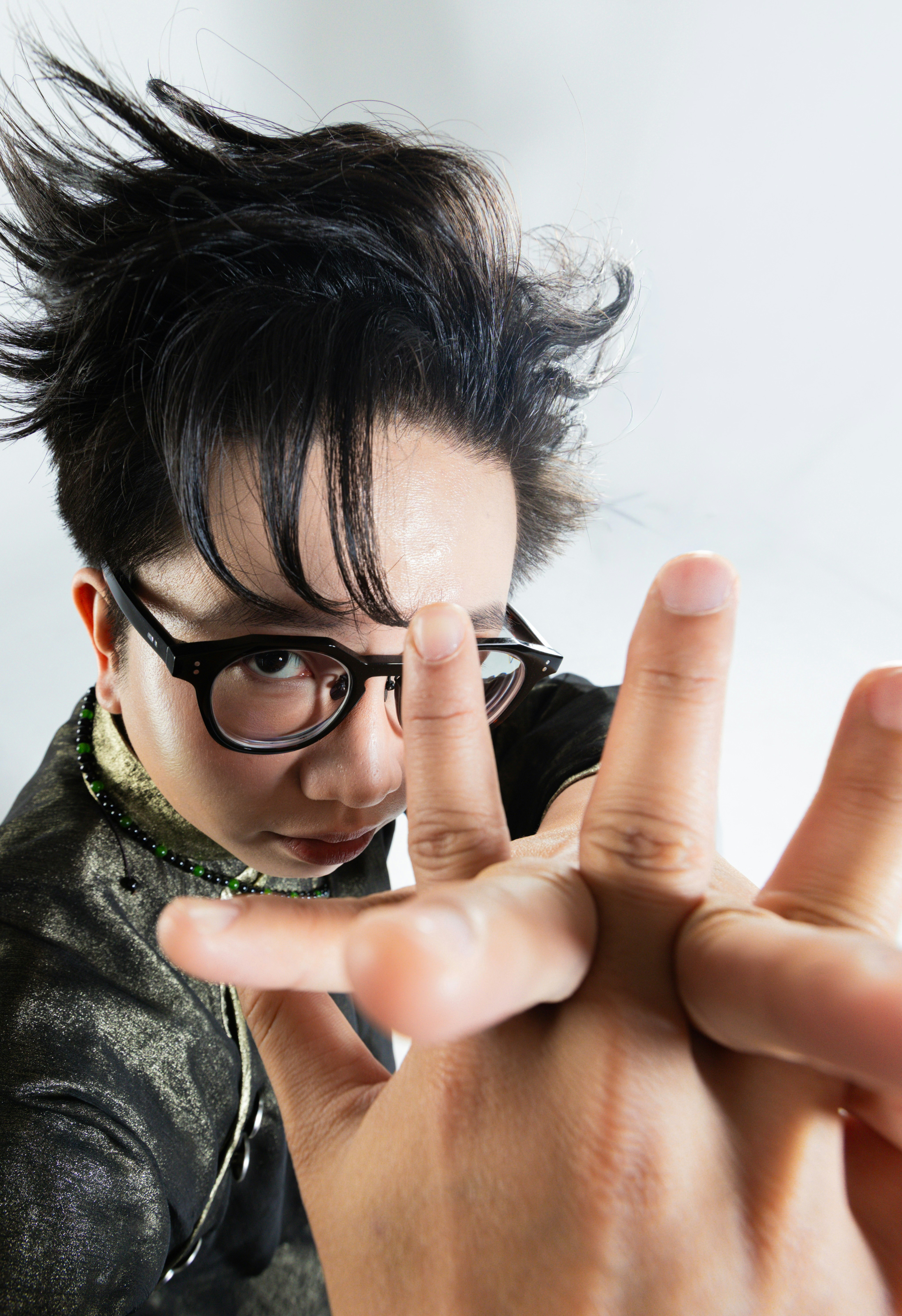 Glassed Gaze: A Bold Close-Up with Hands Framing the Moment