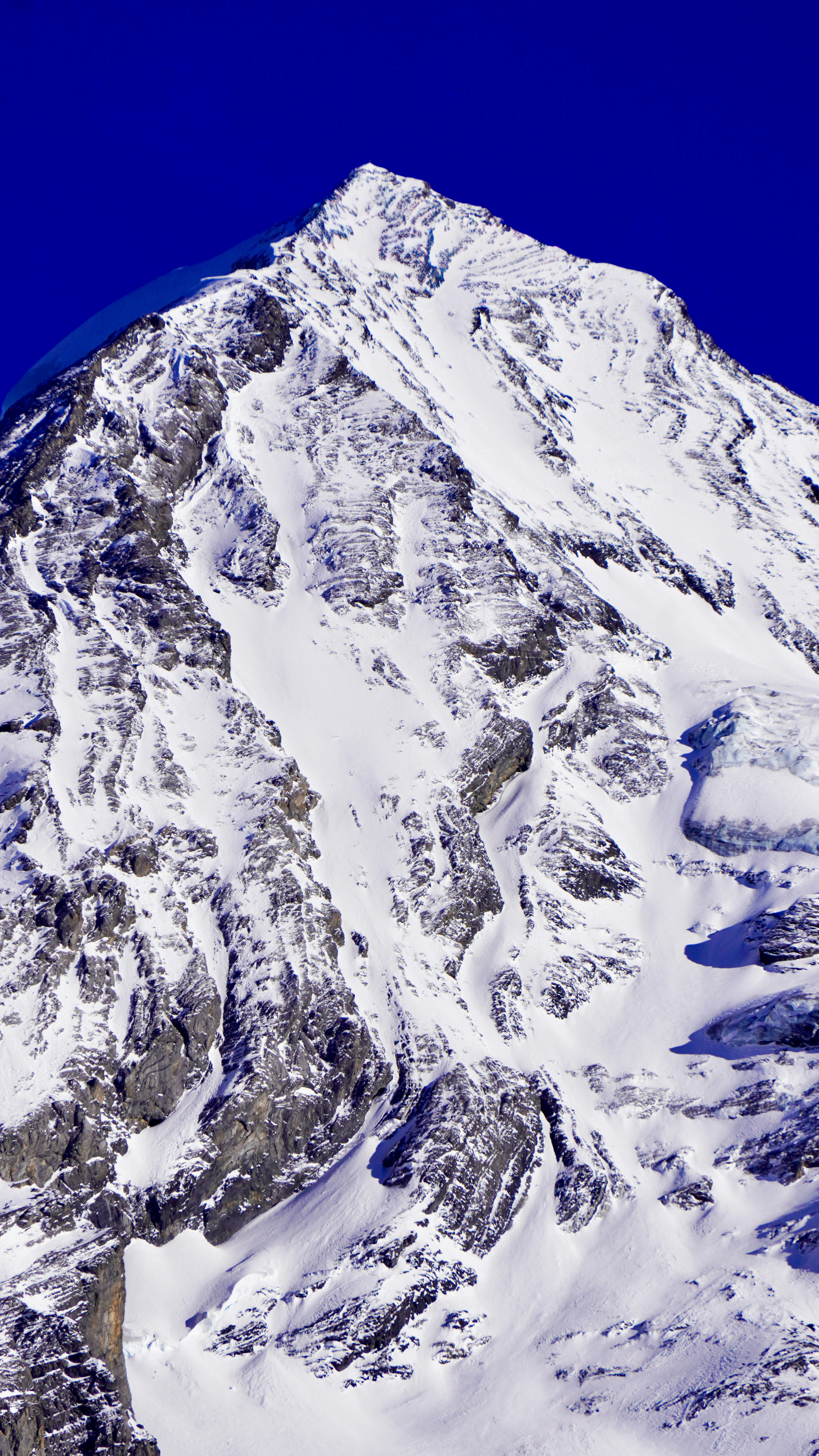 Snowbound Summit Under a Prussian Sky