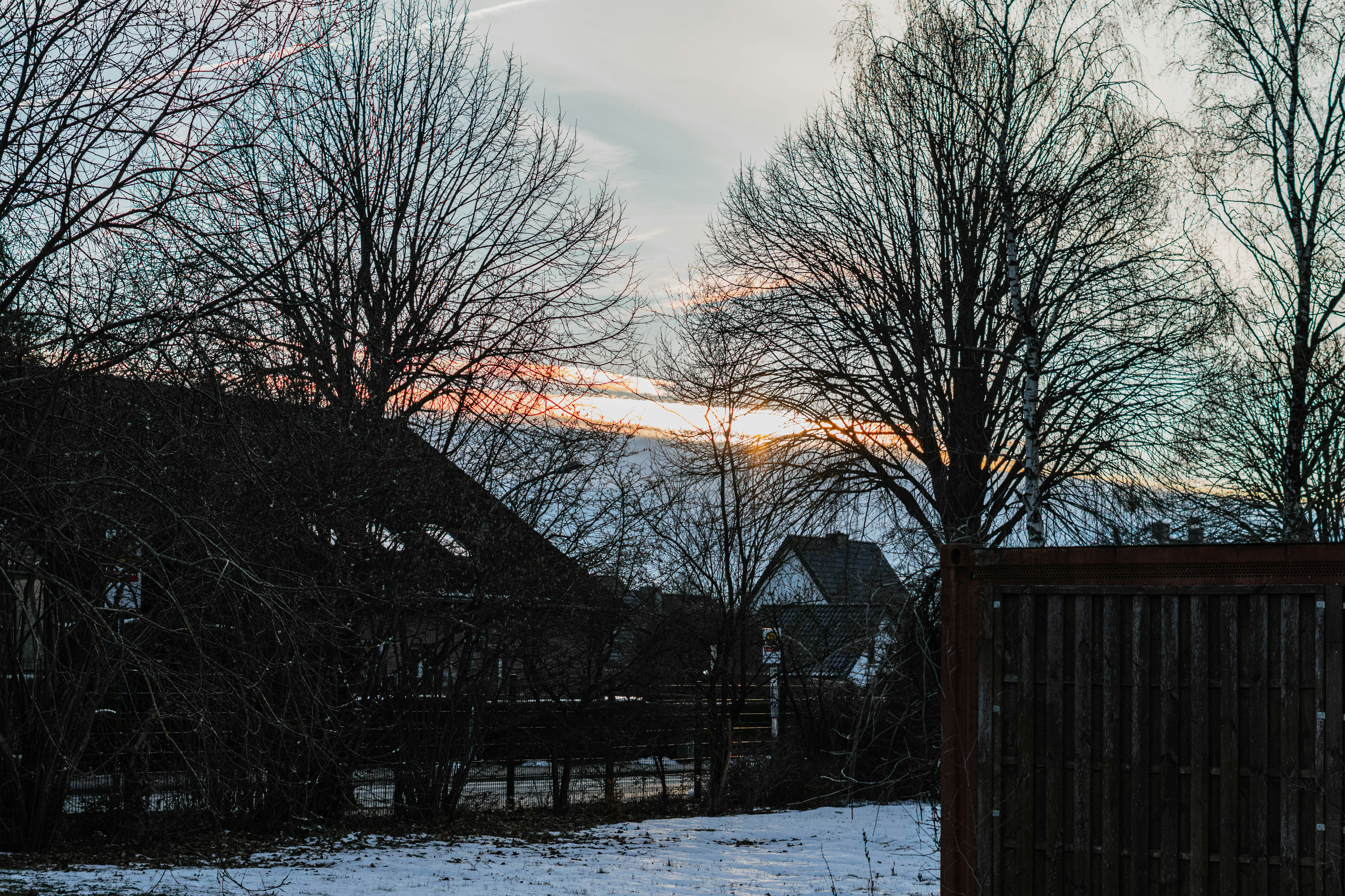 Winter Dusk Behind the Fenced Yard