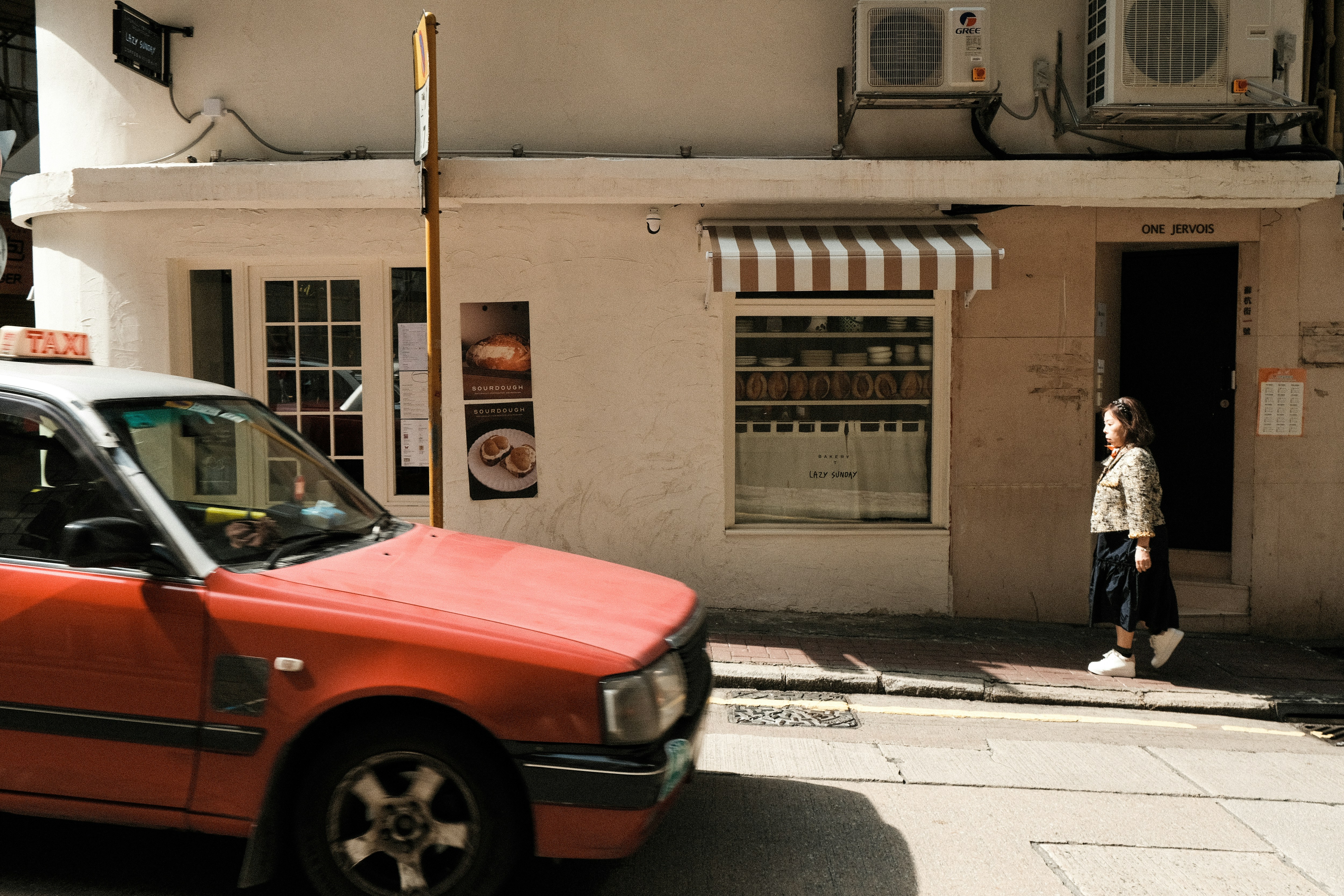 Crossing at the Noon-Taxi: A Quiet Moment on a Sunlit Street