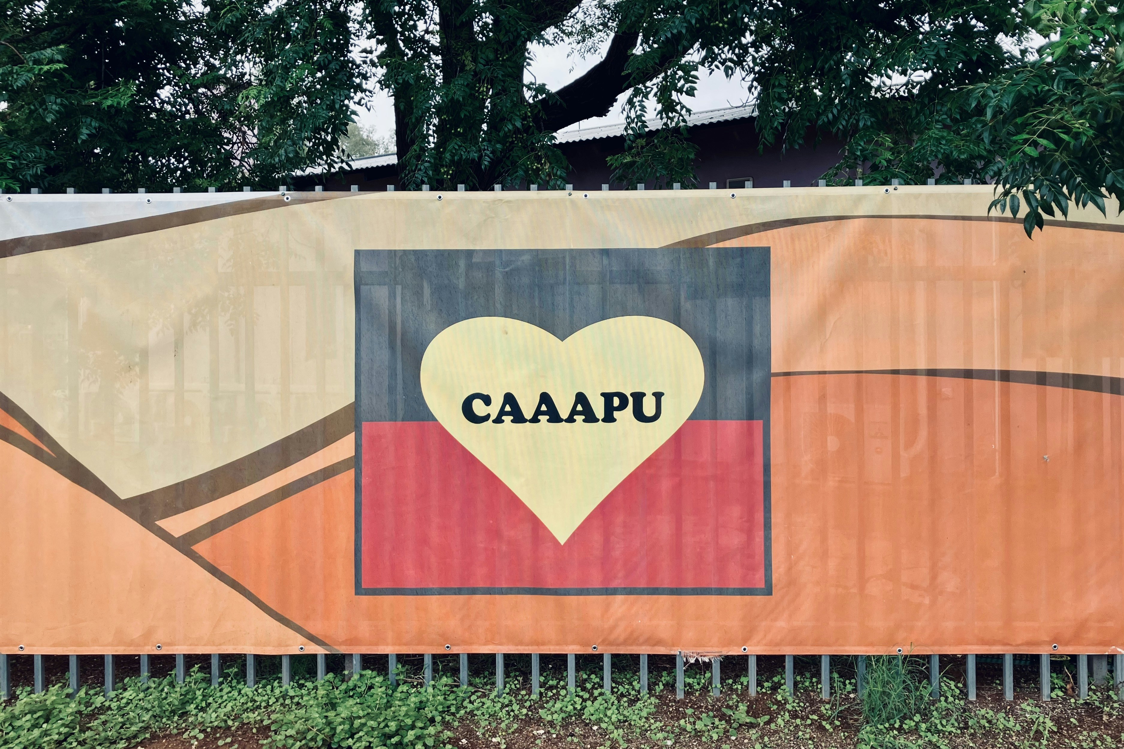 Heart of Color: A mural with a central heart and the word CAAAPU