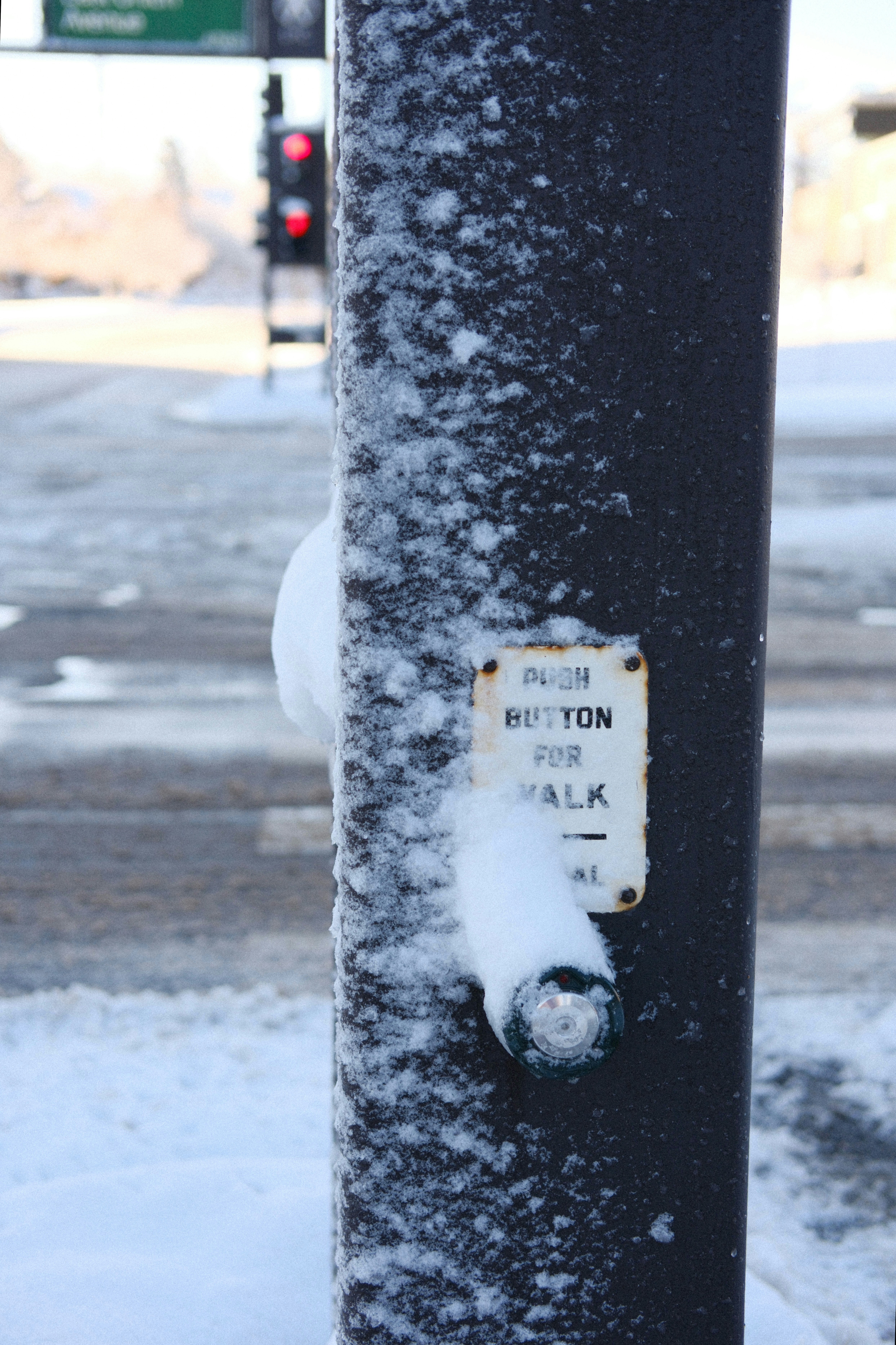 Snow-Covered Pedestal: A Close-Up of a Button in Winter Light