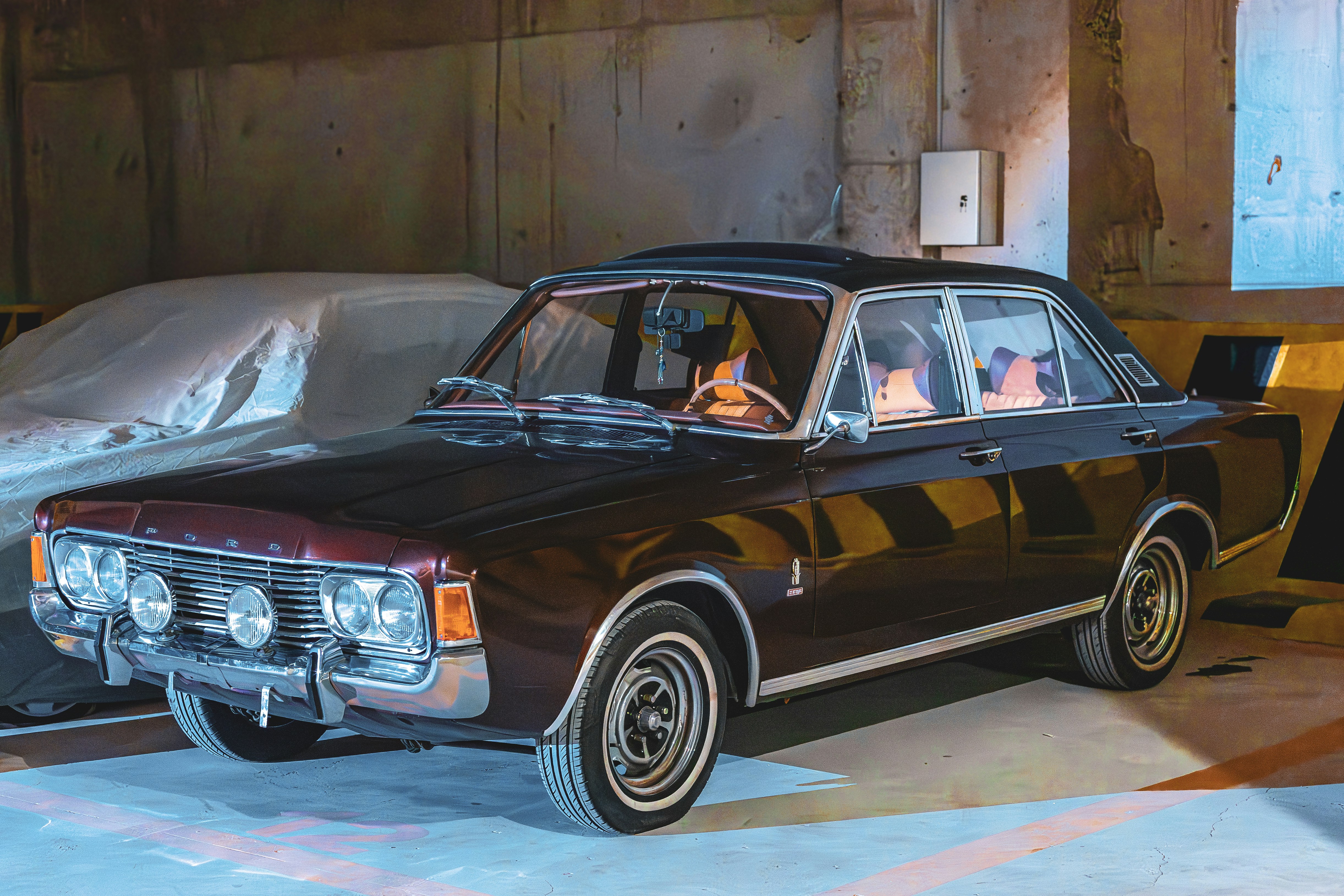 Late-Night Classic: A Vintage Sedan under Industrial Gloom
