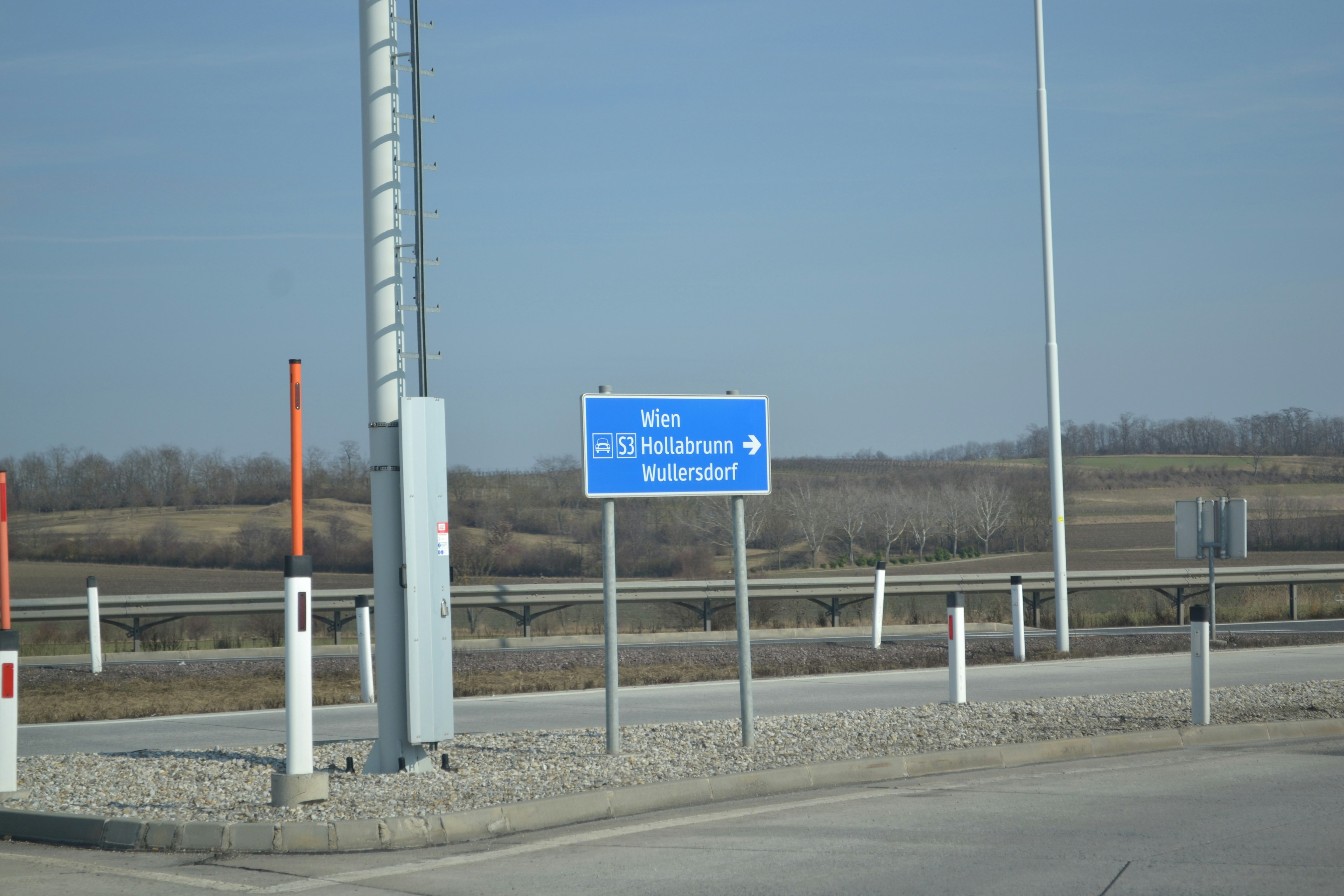 Blue Road Sign Over a Quiet German Highway