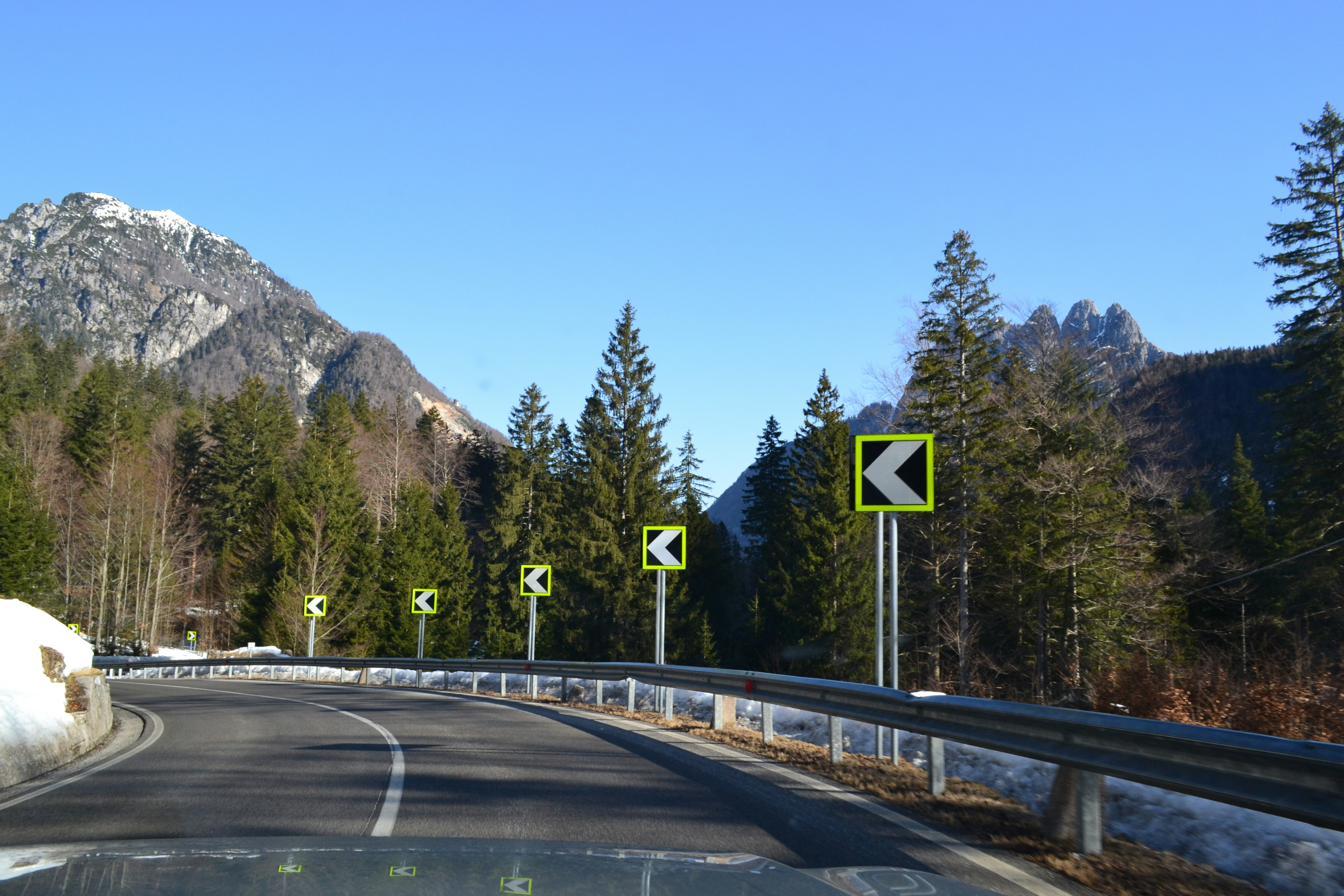 Curved Alpine Road Beneath a Clear Blue Sky