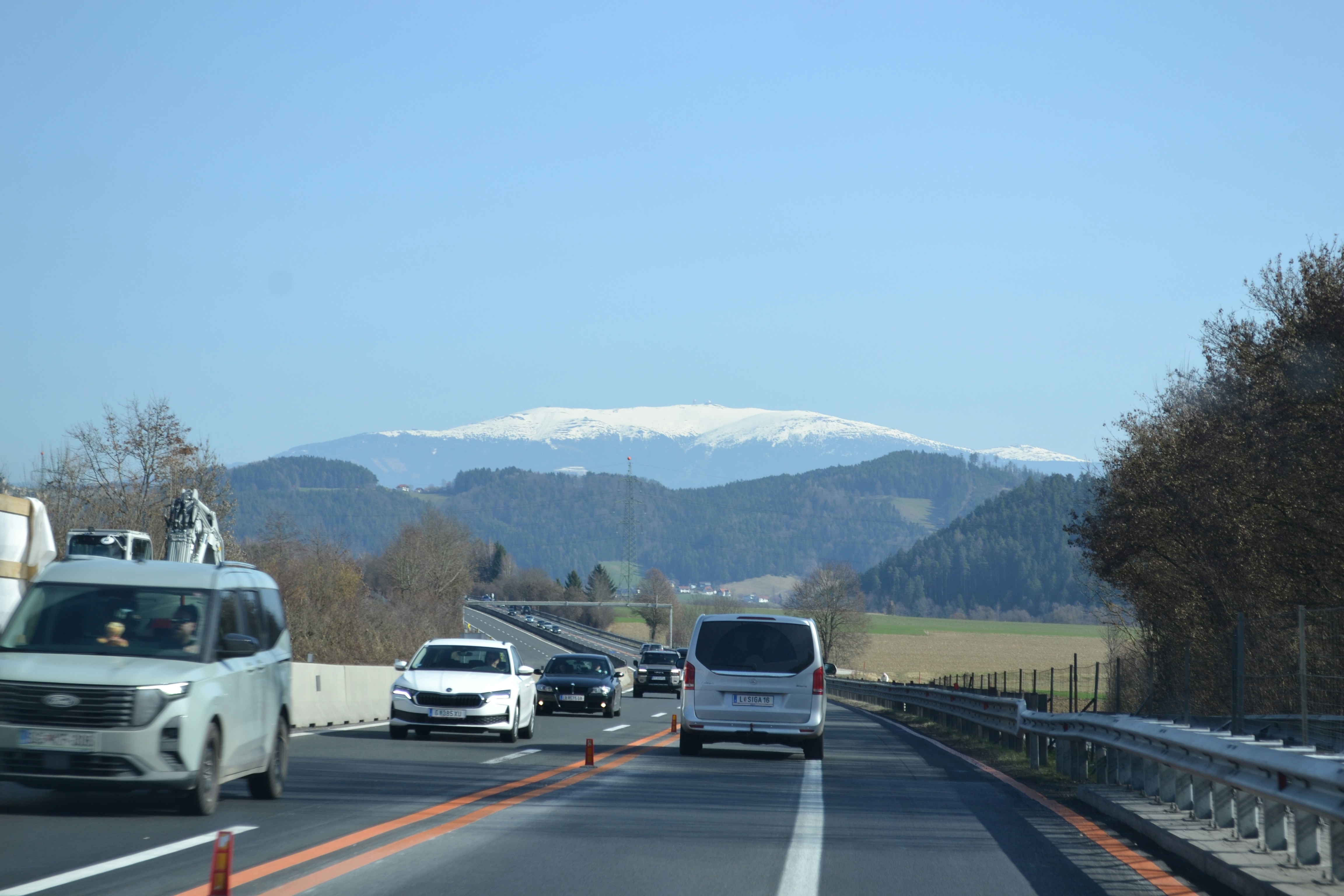 Snow-capped Ridge at Distant Horizon Behind Rolling Highway