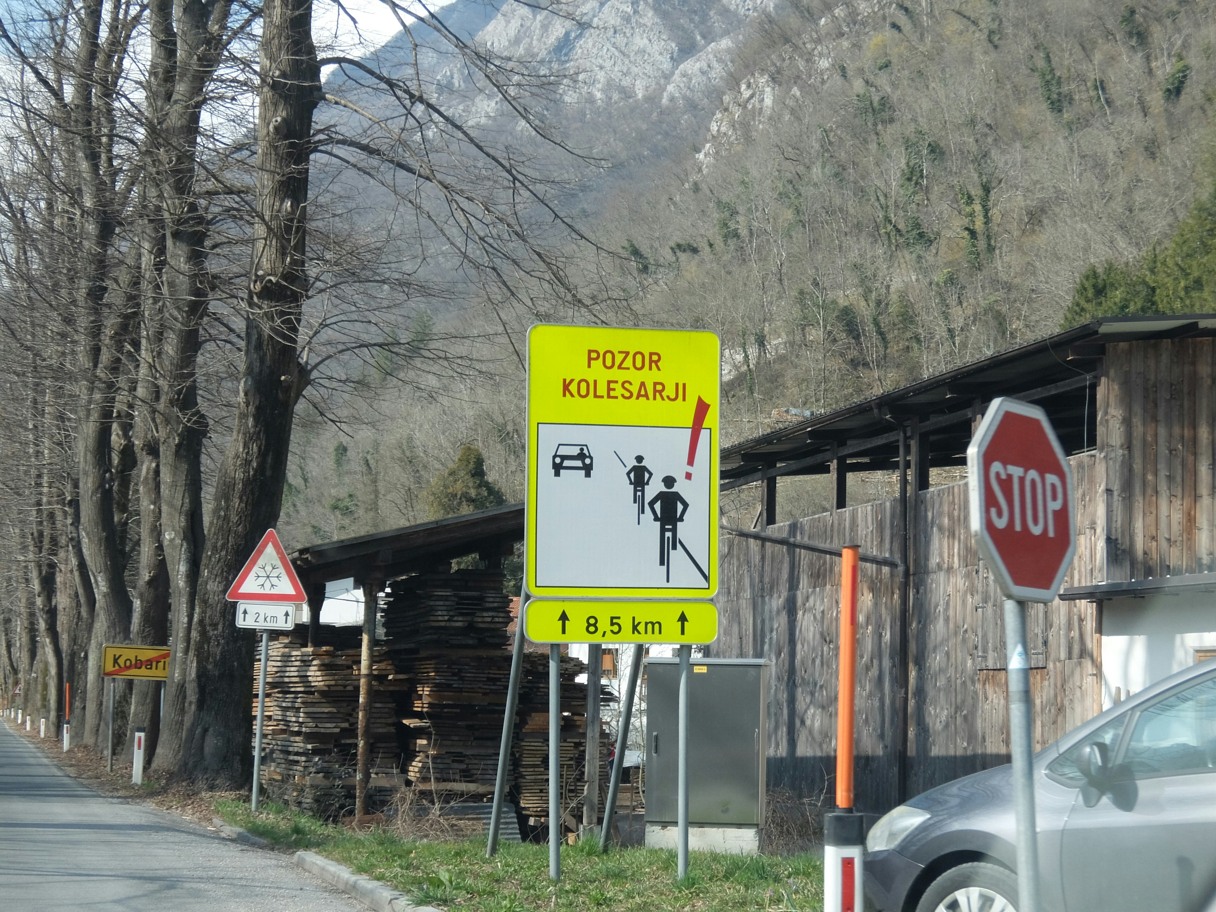Yellow road sign with bicycle and car symbols