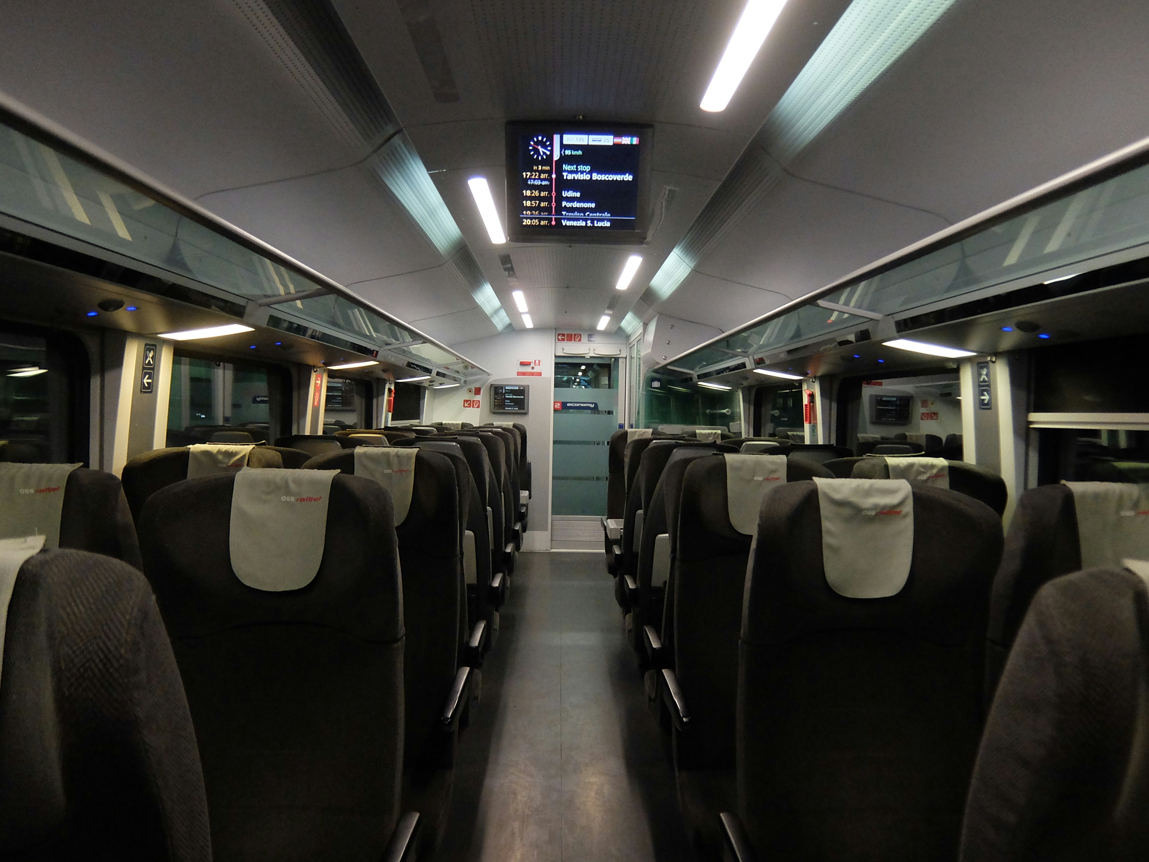 Empty train carriage with rows of seats