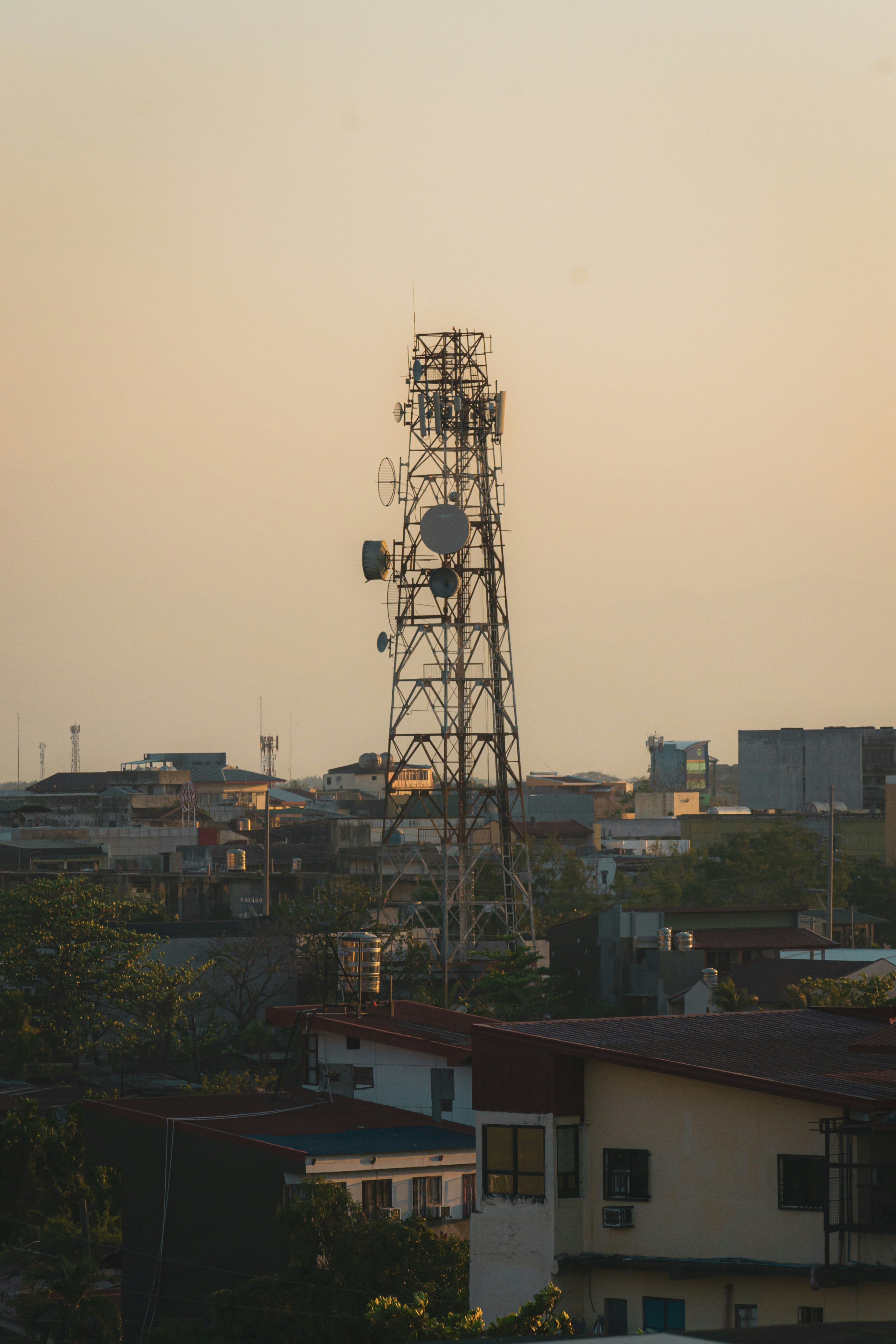 Urban Radio Tower Beneath a Golden Dusk Sky