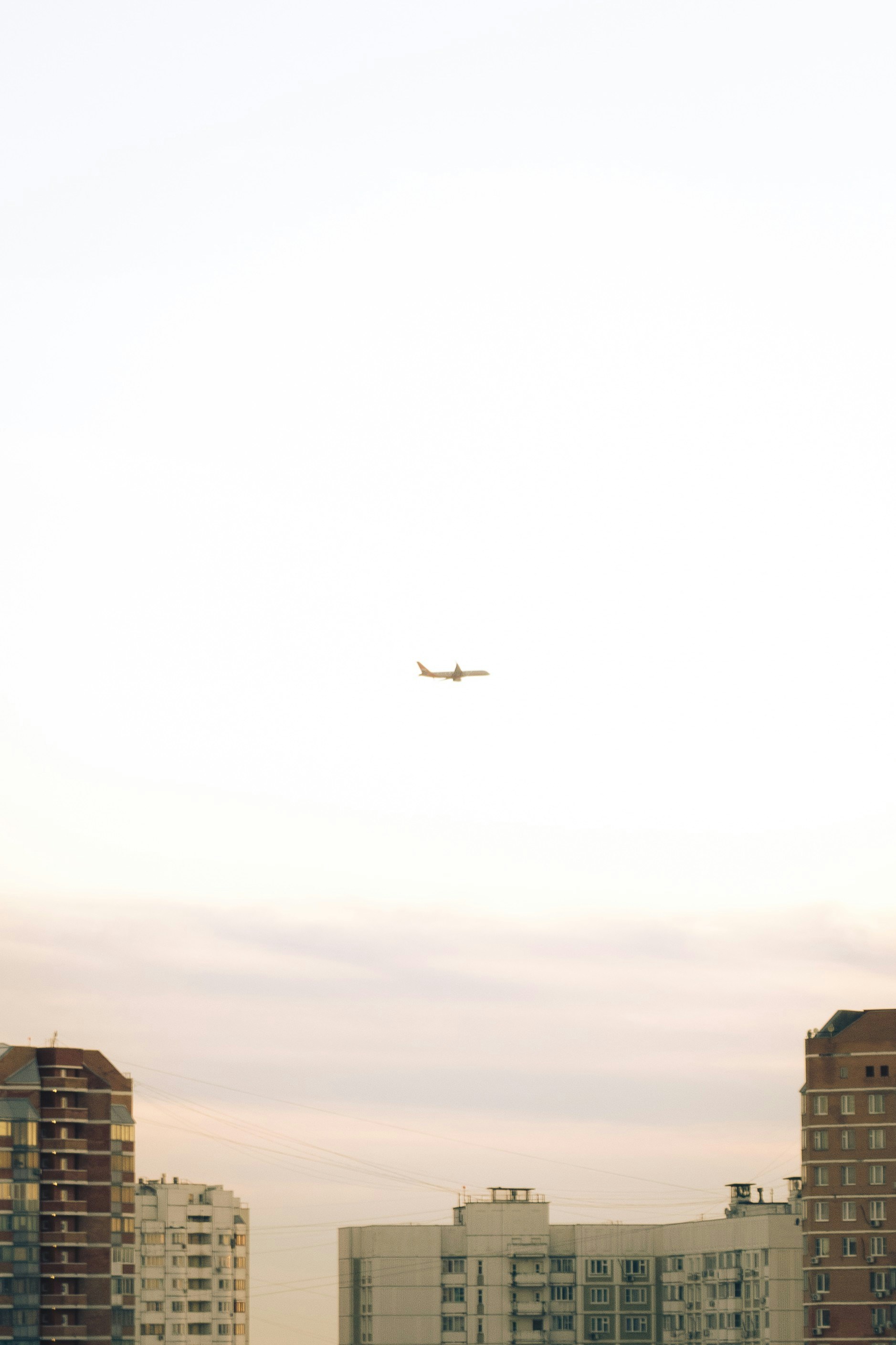 Airplane Crossfade Over a Quiet City at Dusk