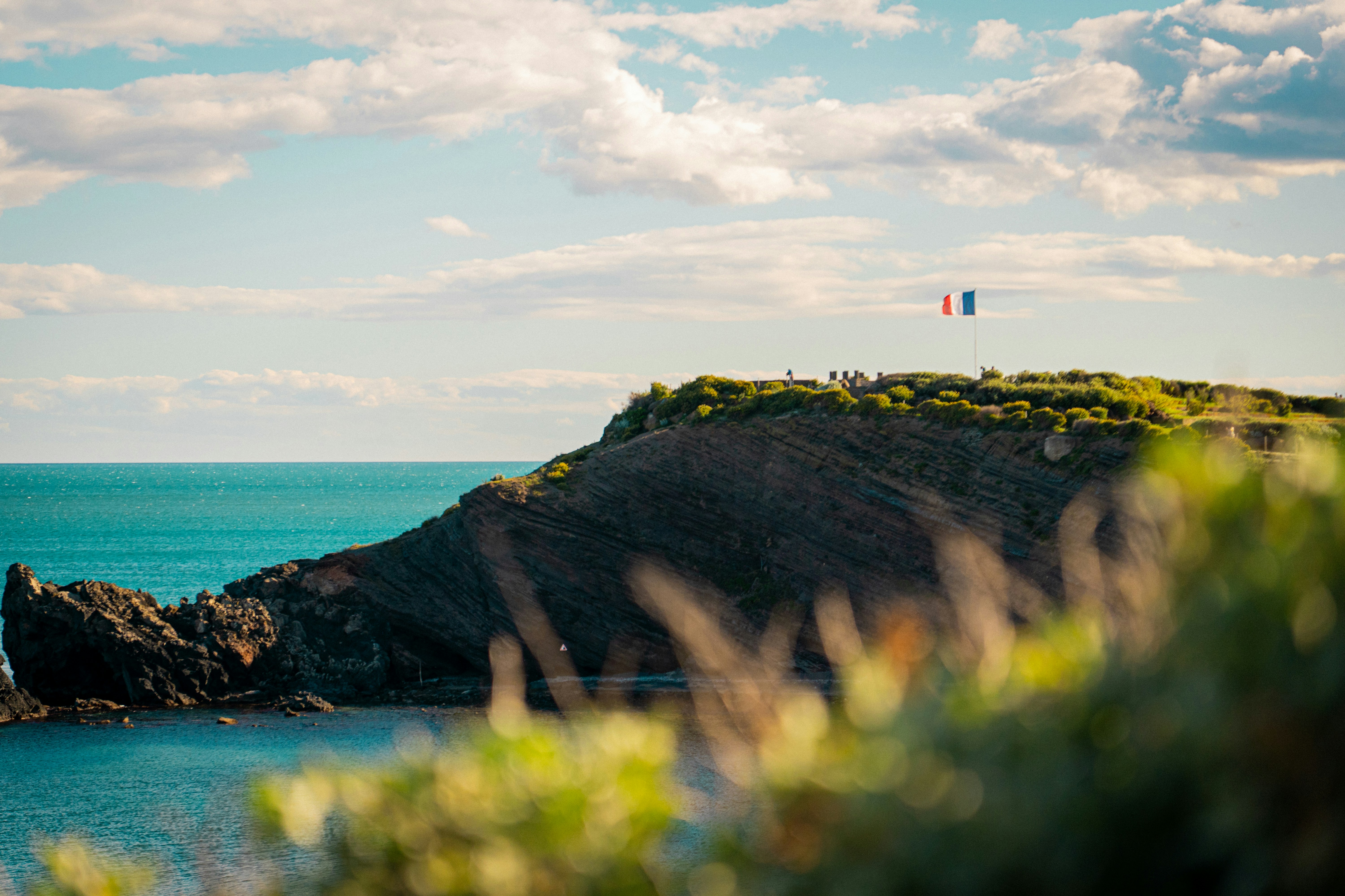 Flag at the Cliff: A Quiet Cape Scene