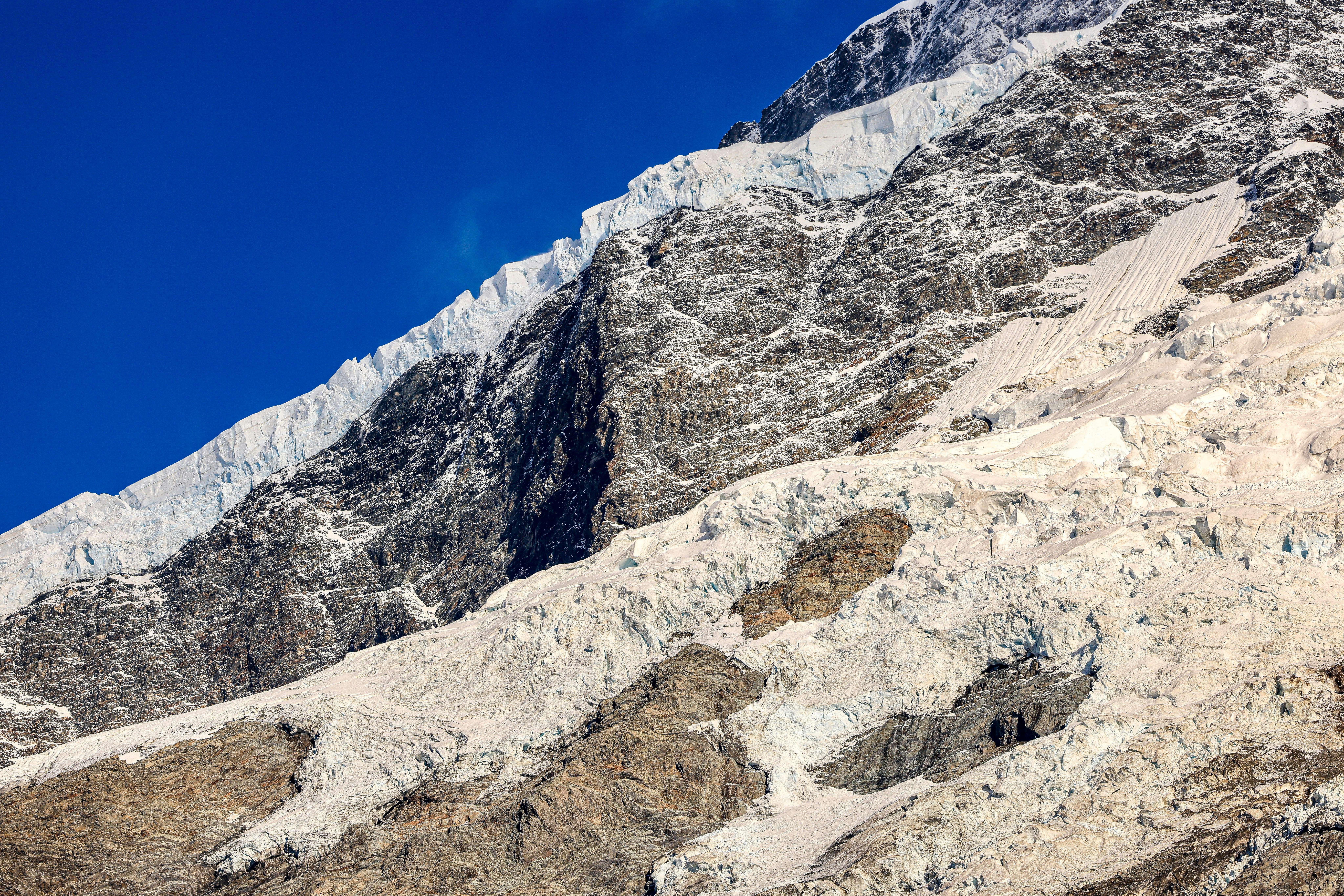Rugged Granite Facade Beneath a Deep Alpine Sky