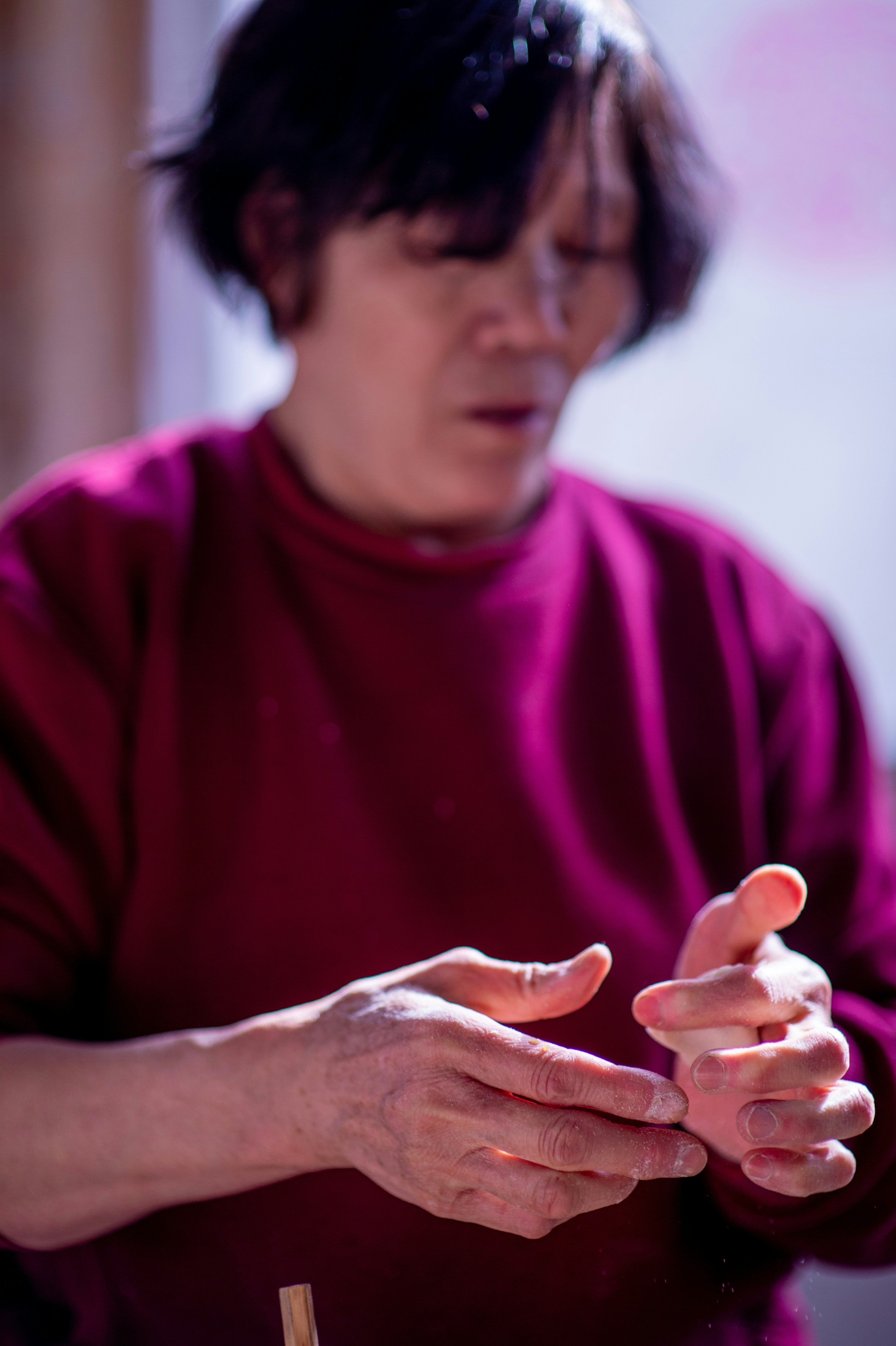 Hands in Motion: Quiet Focus over a Burdened Moment