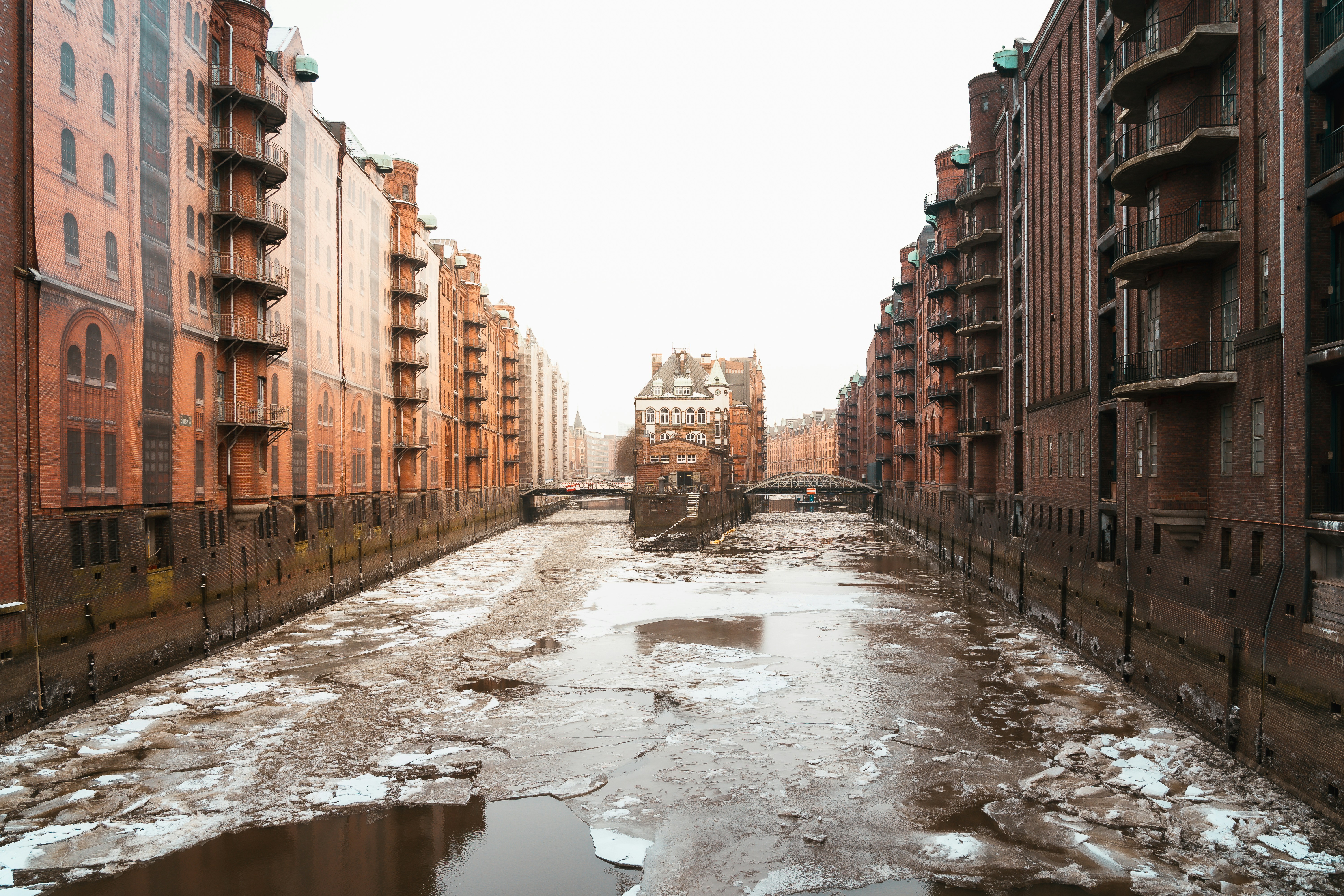 Symmetrical Canal Between Brick Warehouses with a Distant Vessel