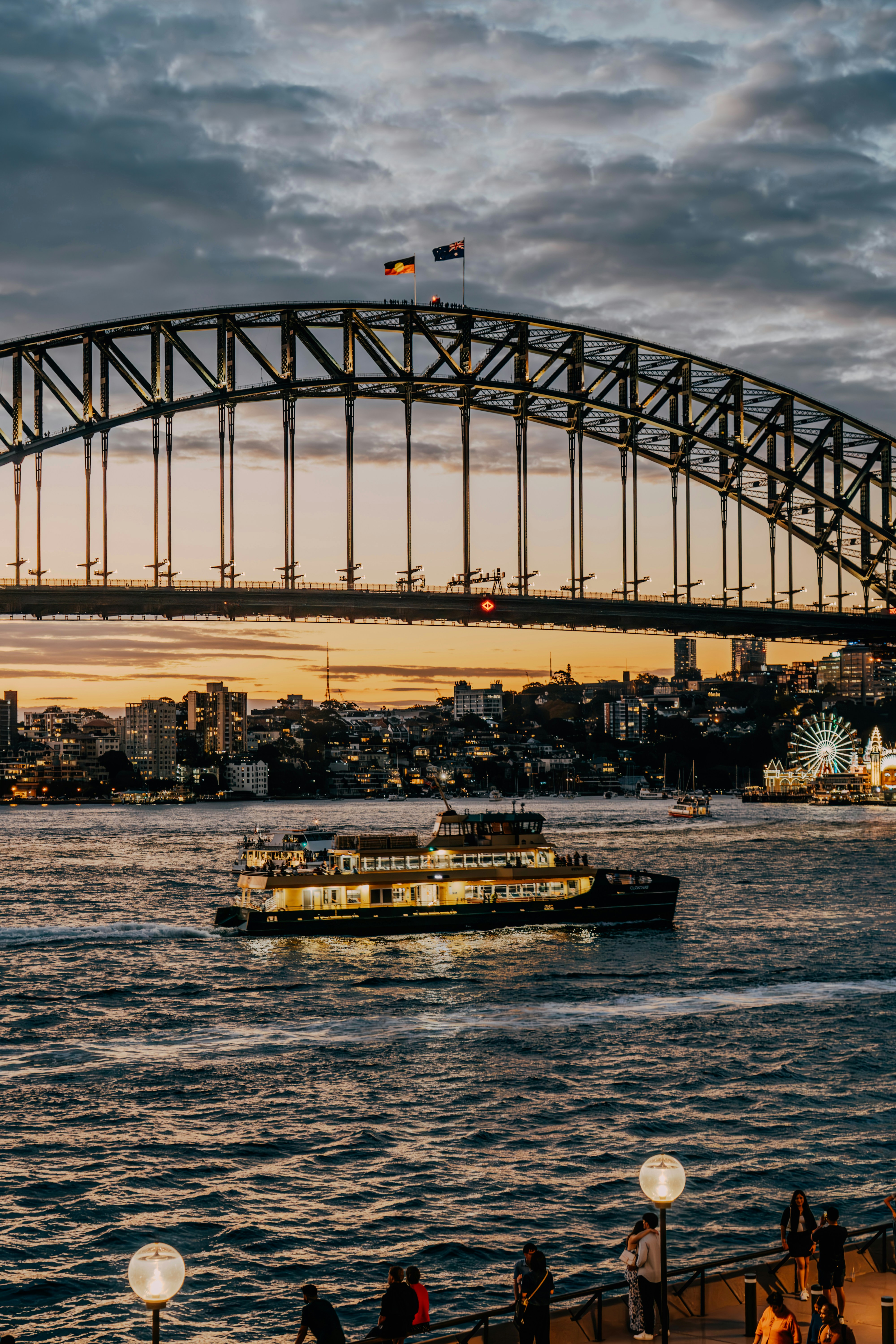 Sunset over the Harbour Bridge: City, Boat, and Ferris Wheel