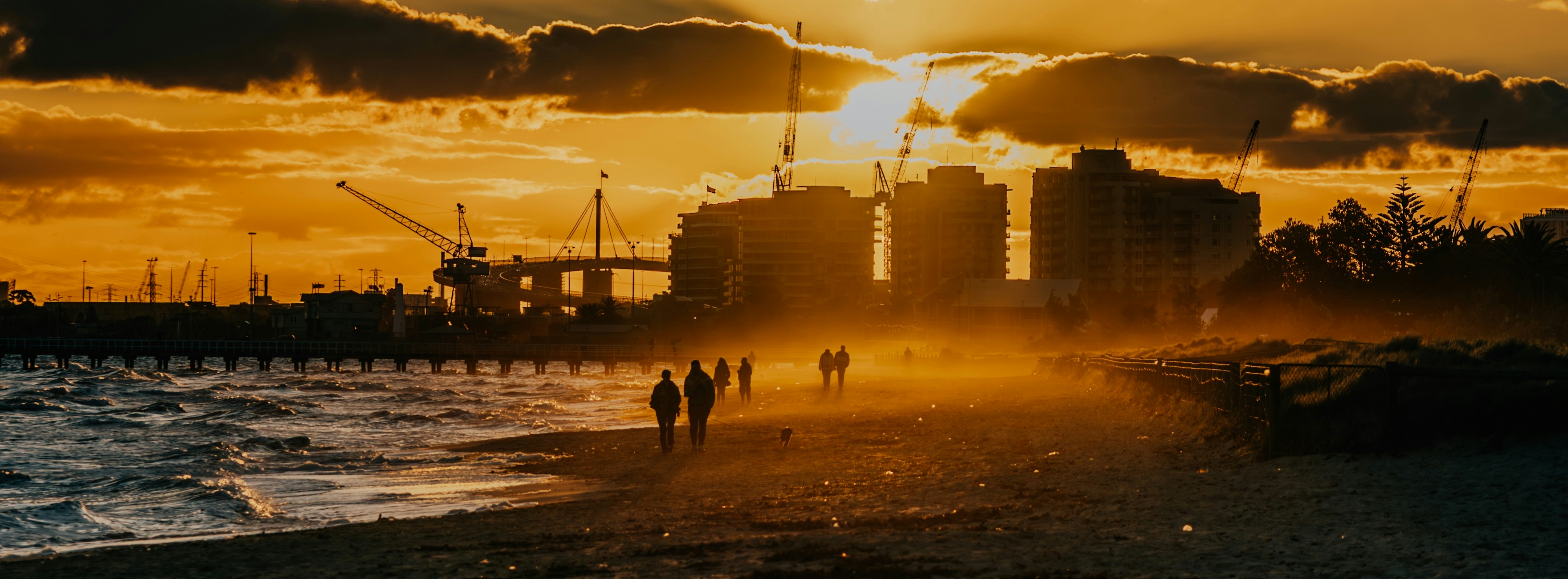 Amber Horizon: Silhouettes Against a Coastal Sunset