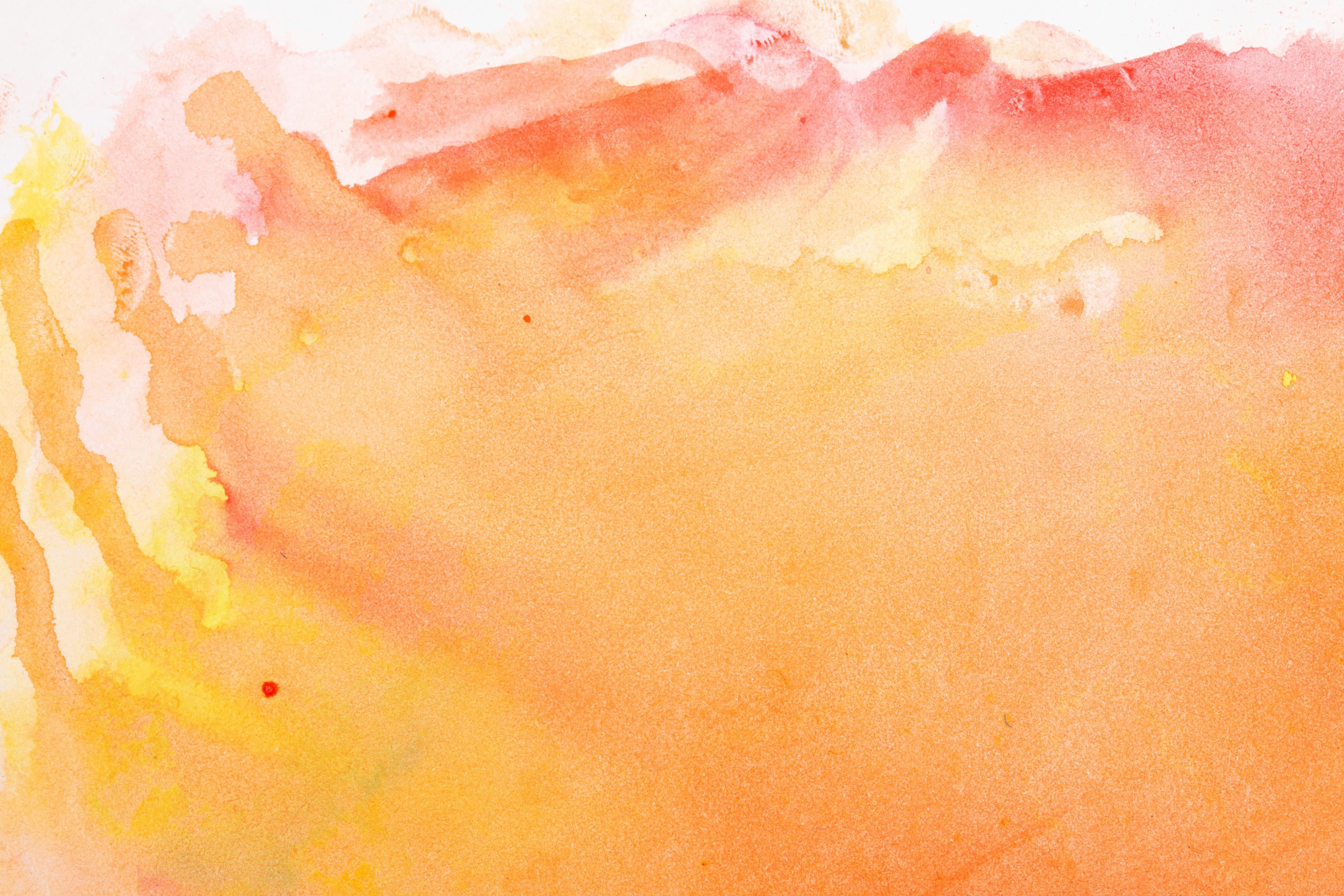 Soft watercolor wash blending peach and coral hues with hints of yellow along the lower left; no discernible subject, diffuse gradient texture suitable for background or abstract art.