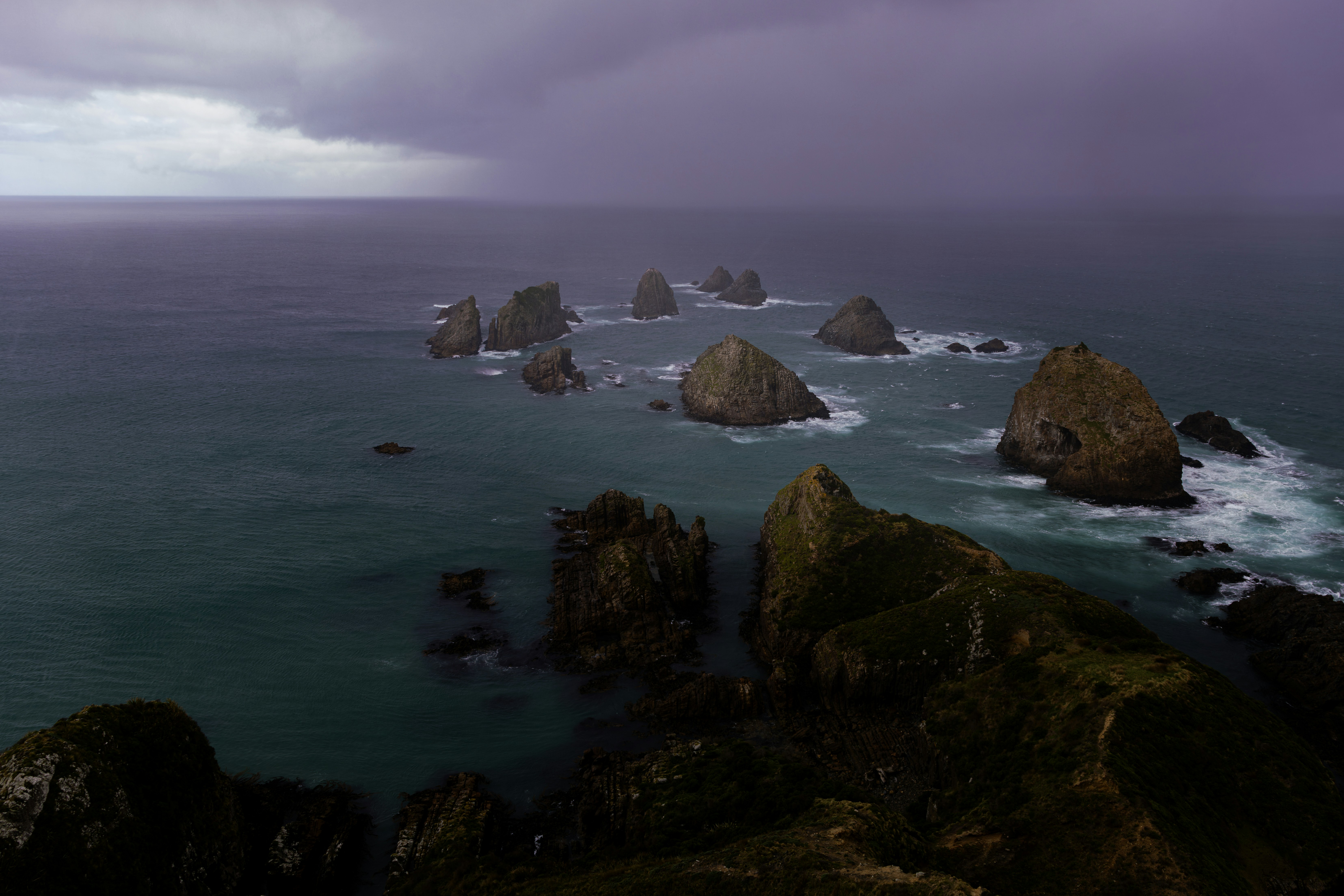 Rugged Sea Stacks under a Stormy Veil