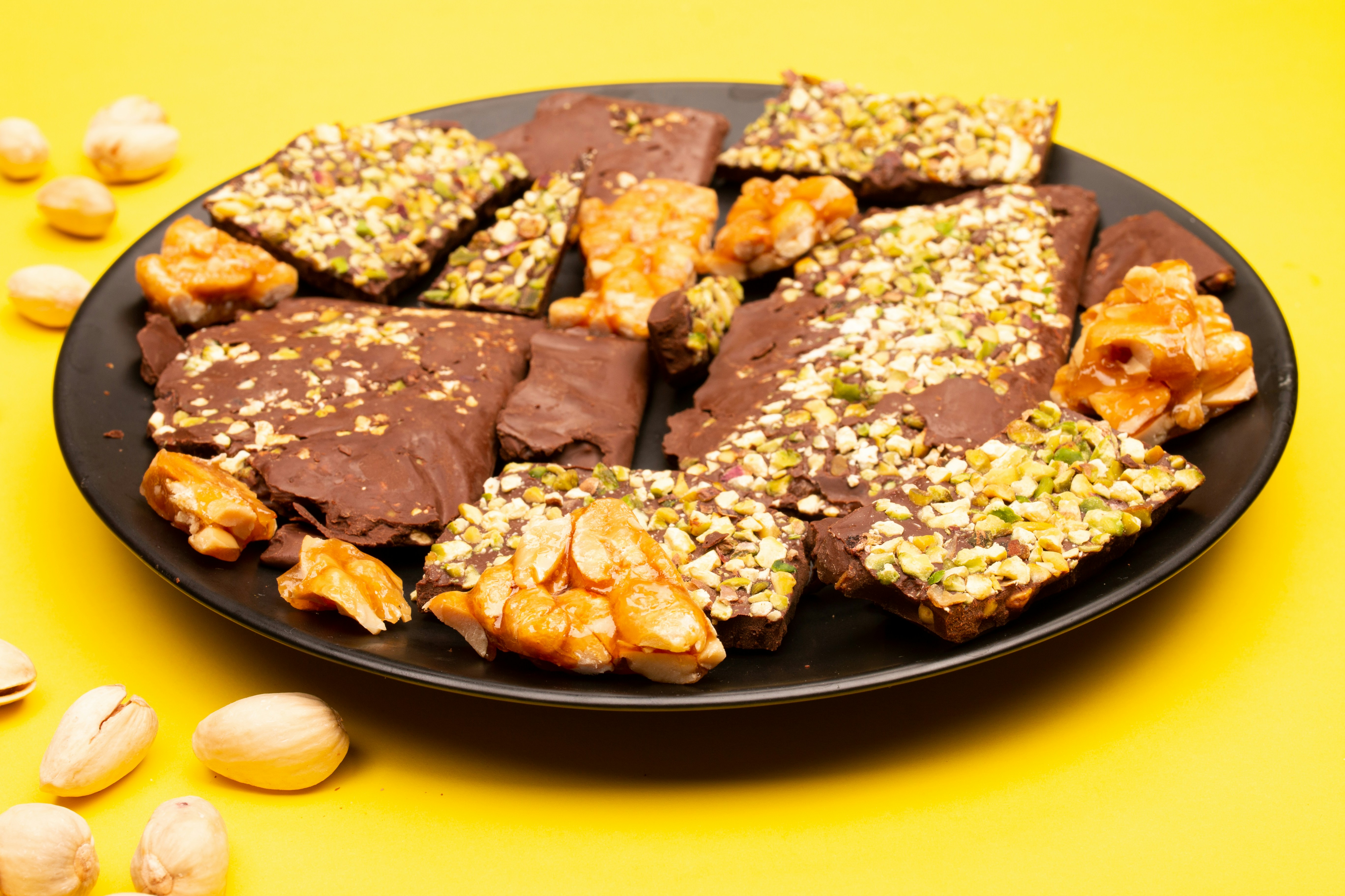 Golden Pistachio-Topped Chocolate Brittle on a Bright Plate
