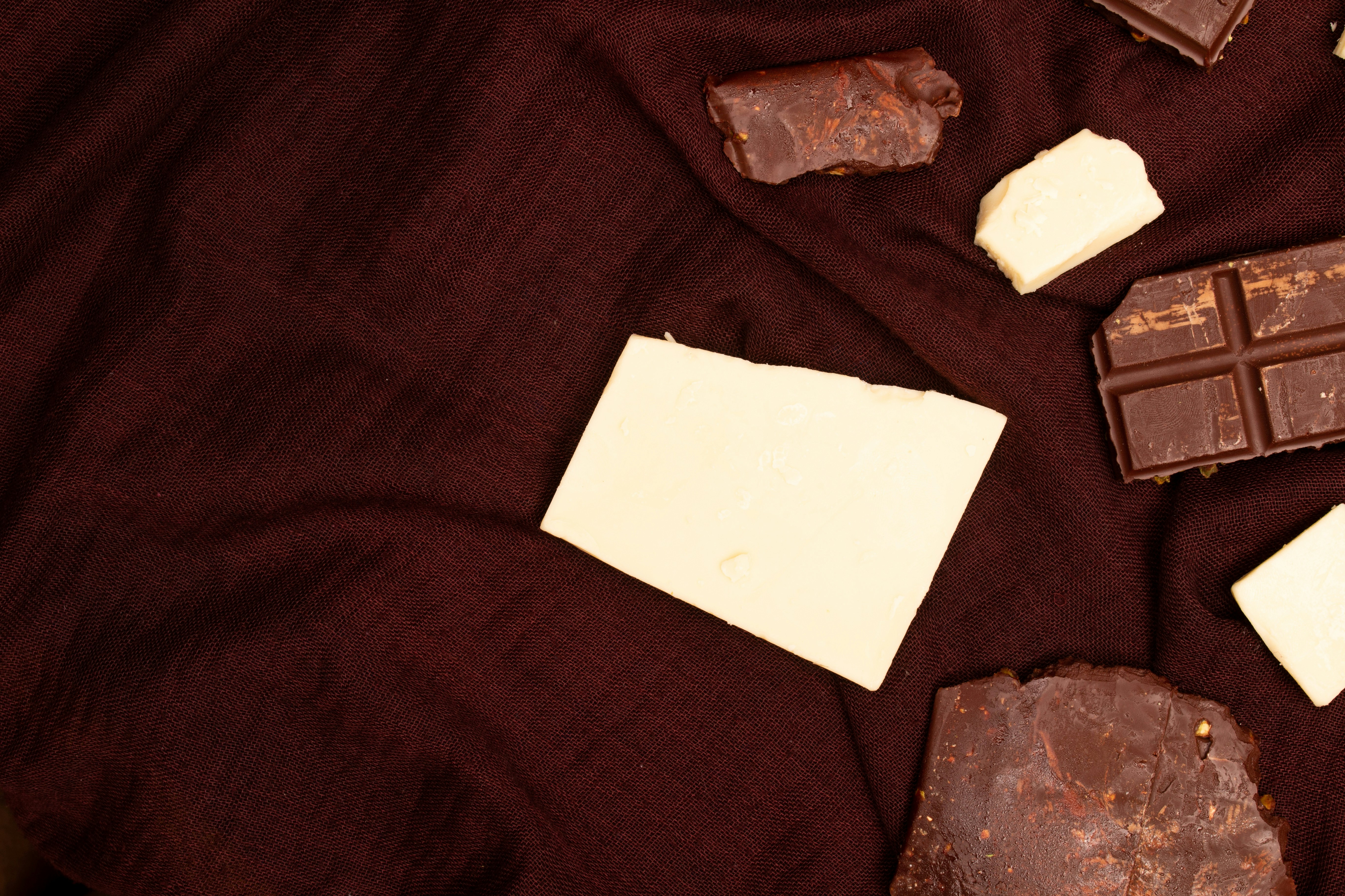 Ivory Chocolate Fragments Resting on a Velvet Dark Murk