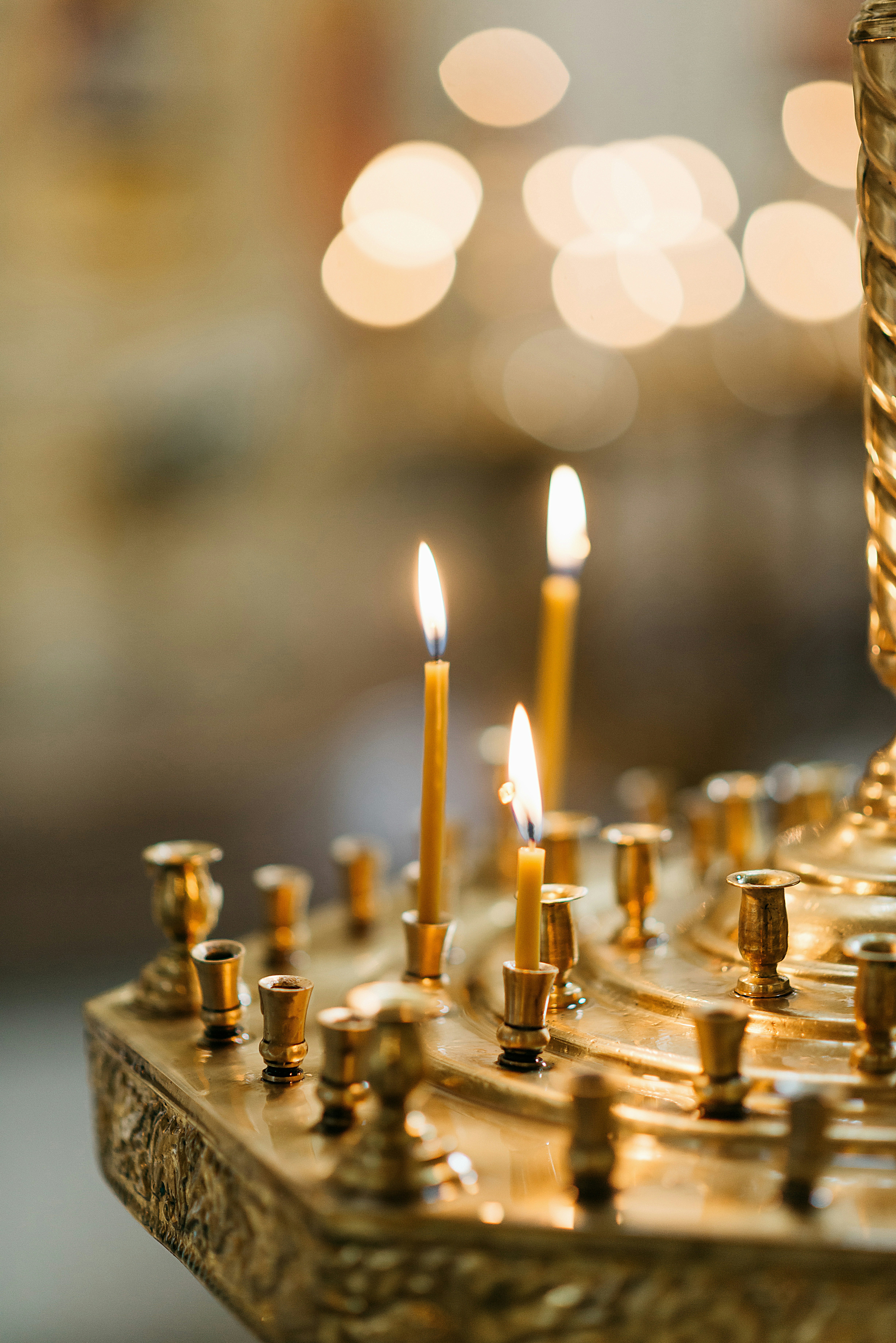 Golden Candelabrum: Focused Flames Amid Velvet Bokeh
