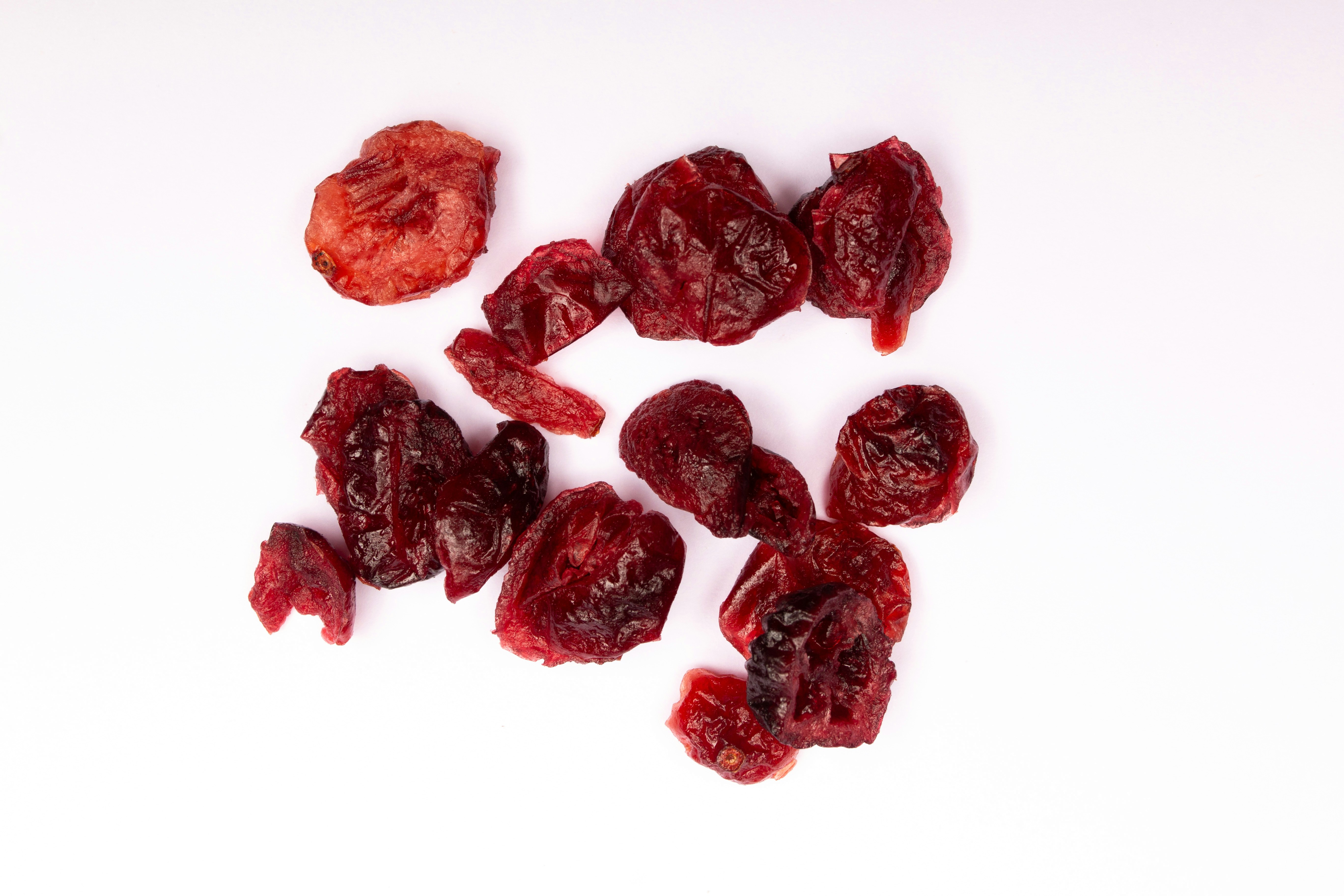 Scatter of Dried Cranberries on White Canvas