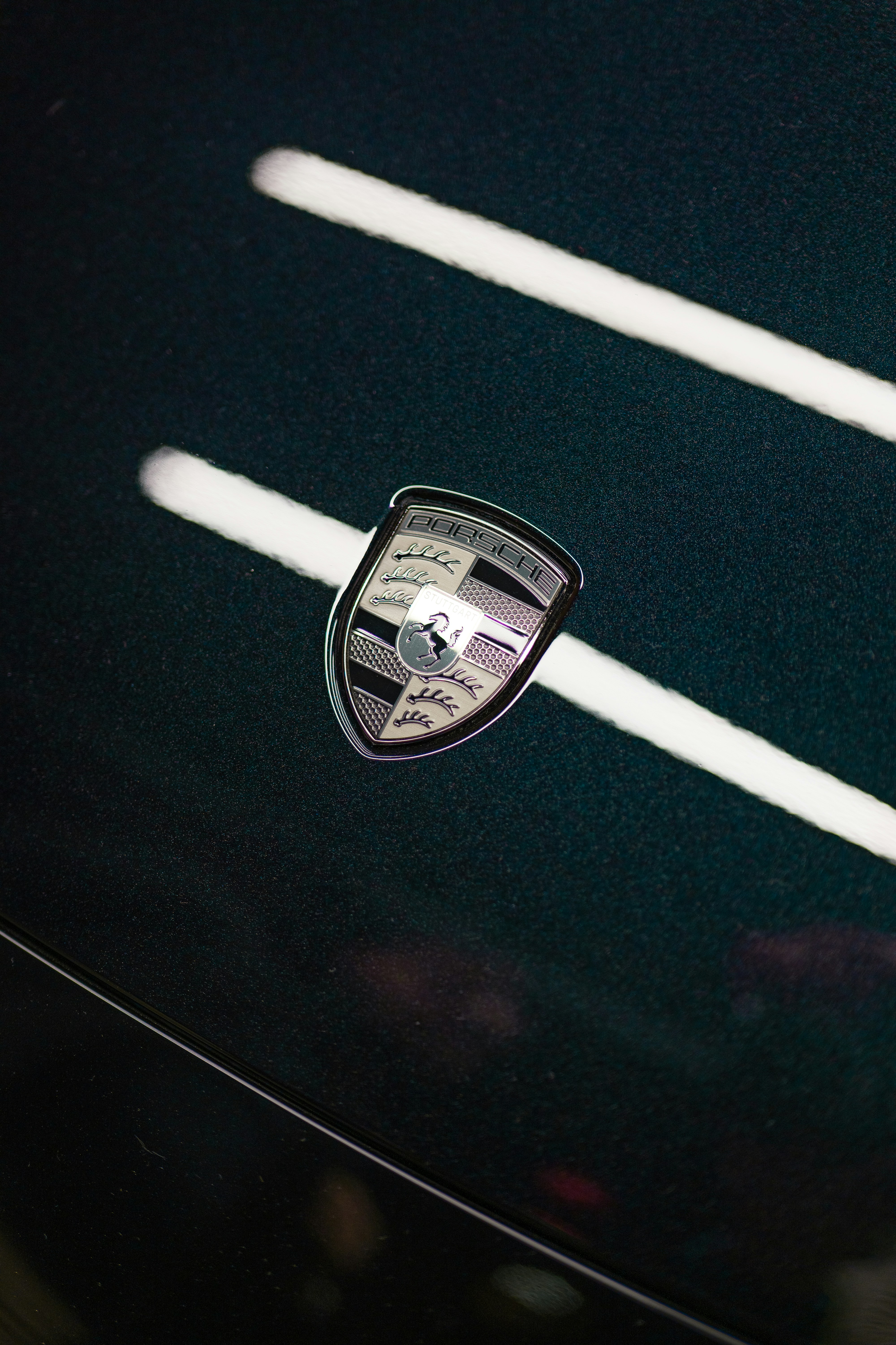 Emblem on a Midnight Porsche: A Quiet Moment of Shine