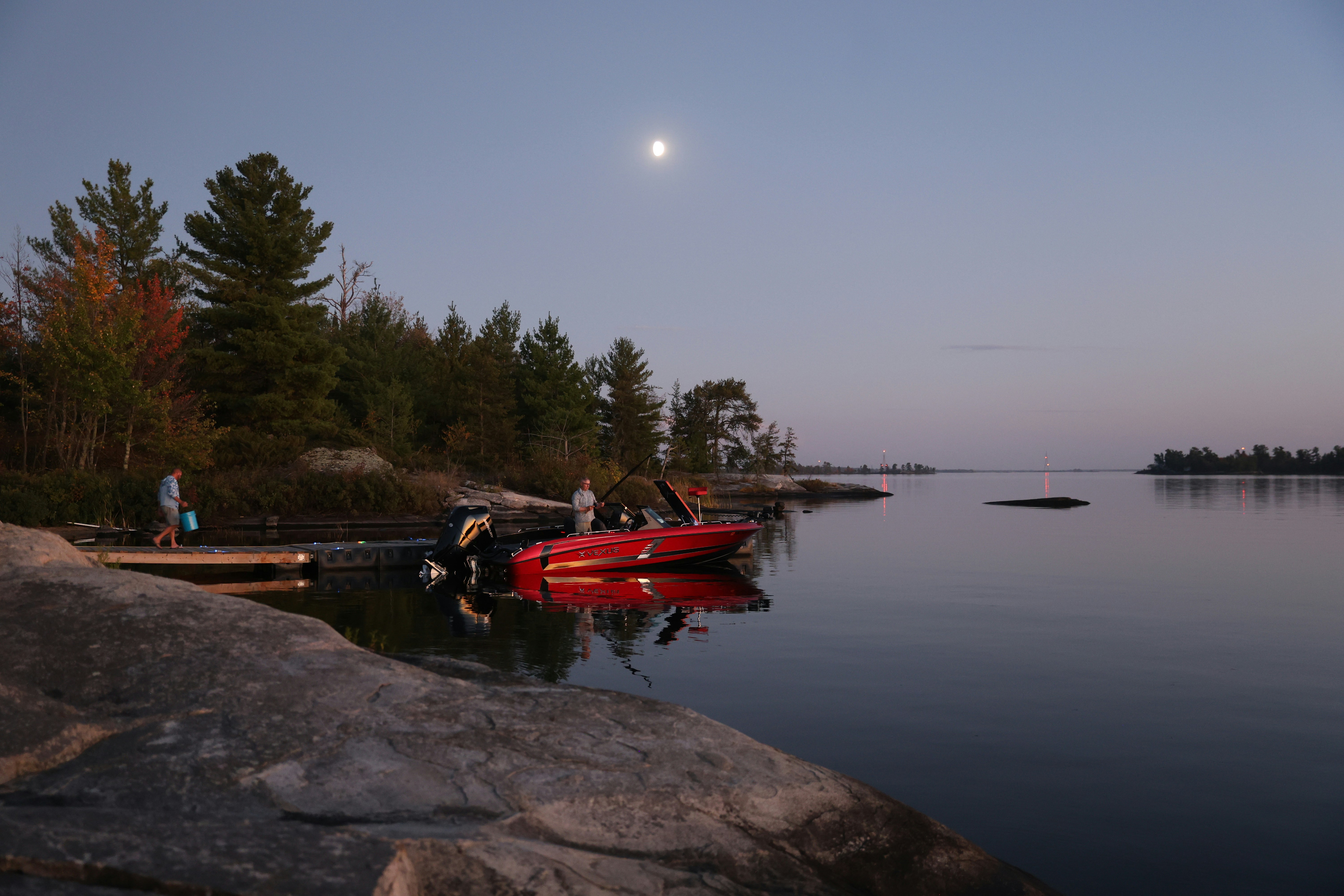 Dawn on the Quiet Jetty: Boats and Moonlight