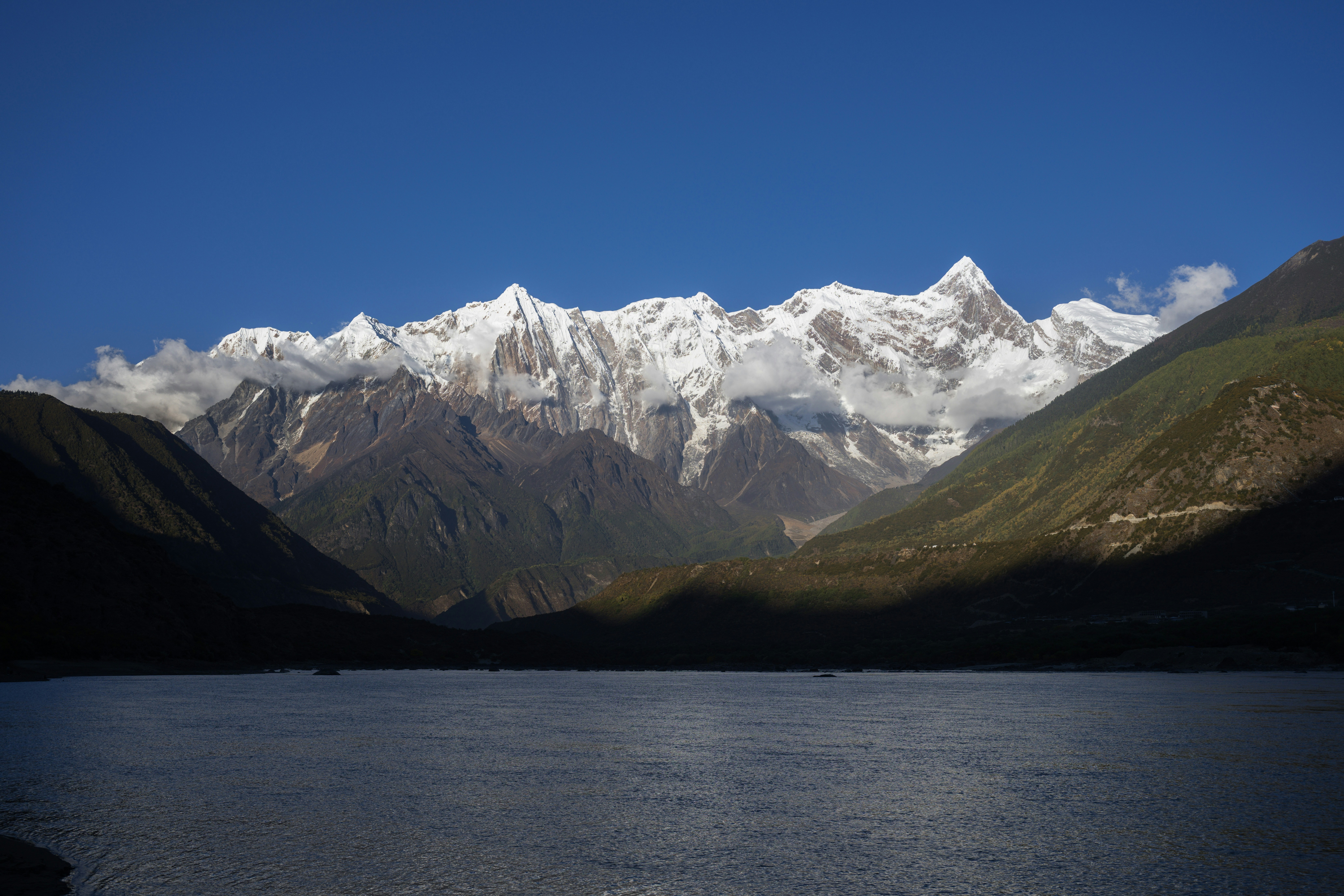 Snow-crowned Peaks Above a Shadowed Fjord