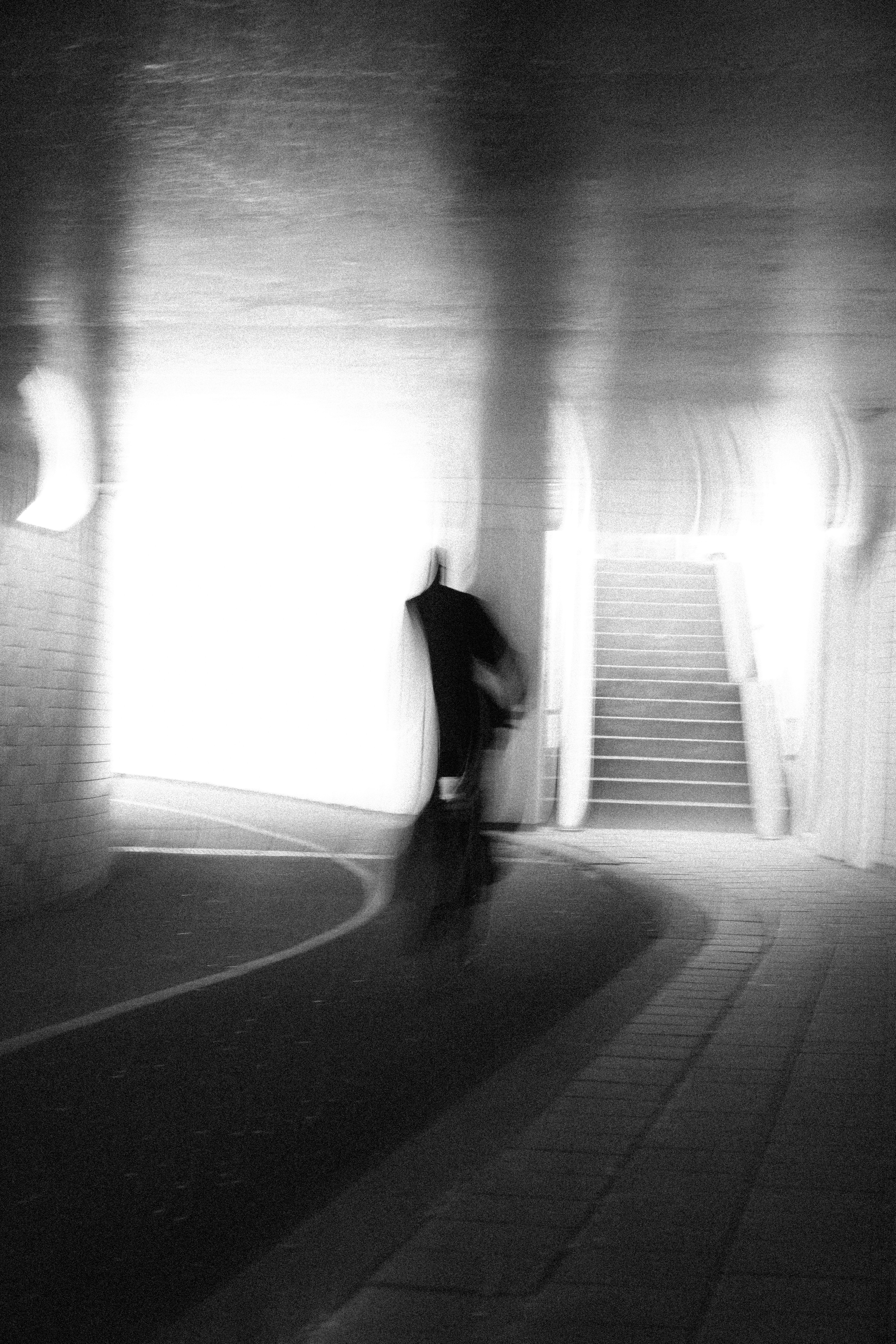 Blurred Runner in a Bright Underpass: A Moment of Motion and Light