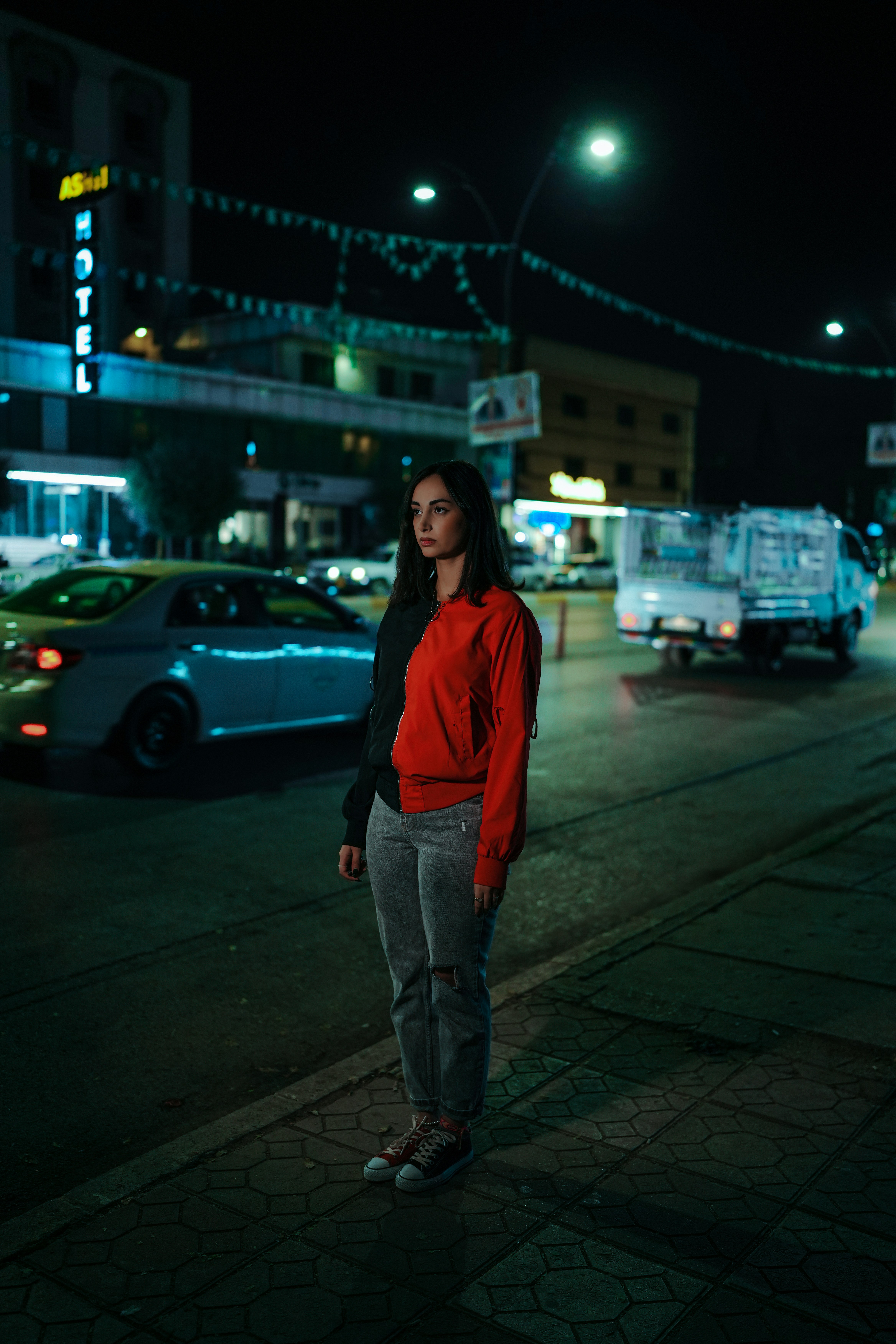Midnight Neon: A Woman in a Red Jacket Under City Lights