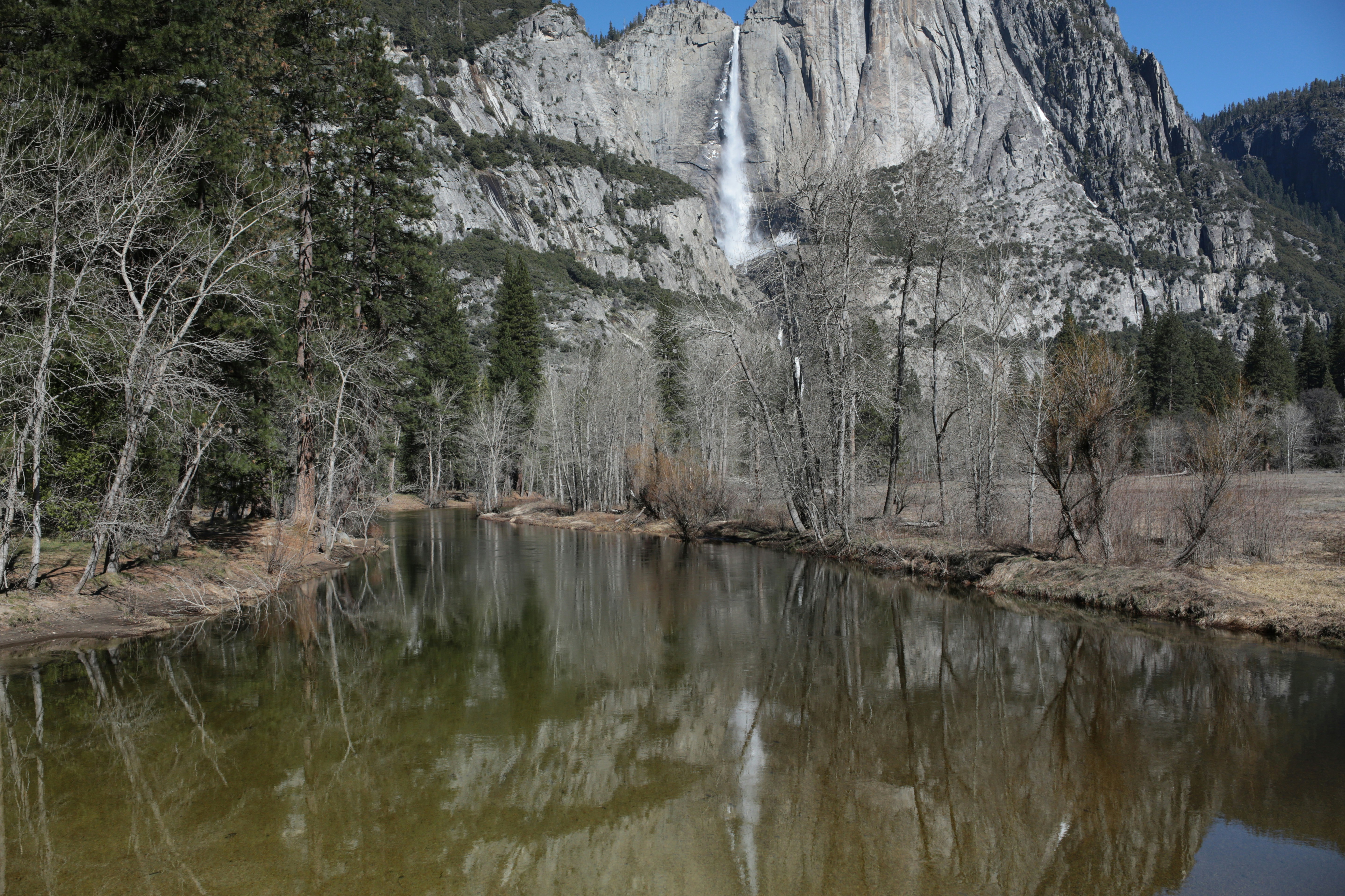 Mirror of the Falls: River Gorge Beneath Granite Peaks