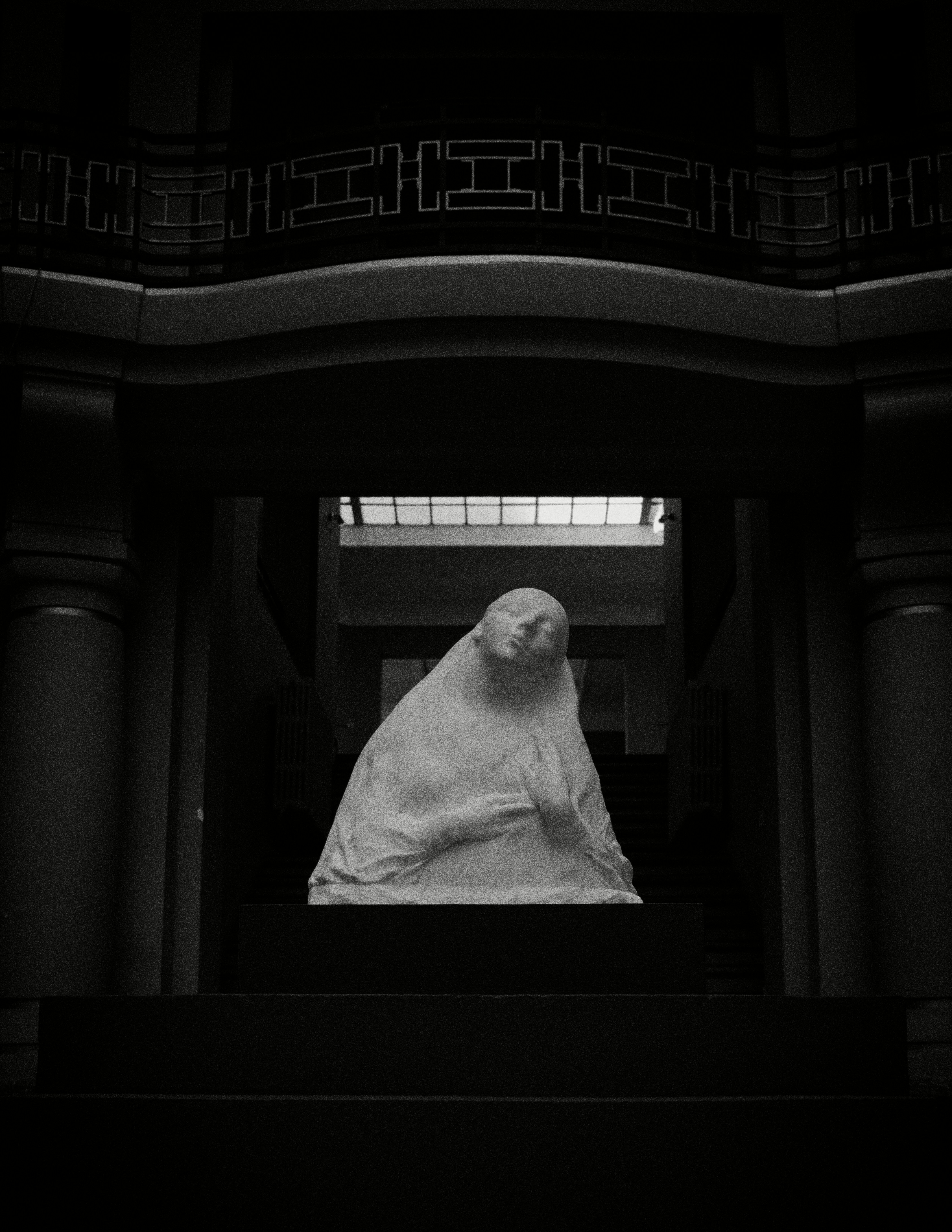 Silent Embrace: A Stone Gargoyle in Dim Silence