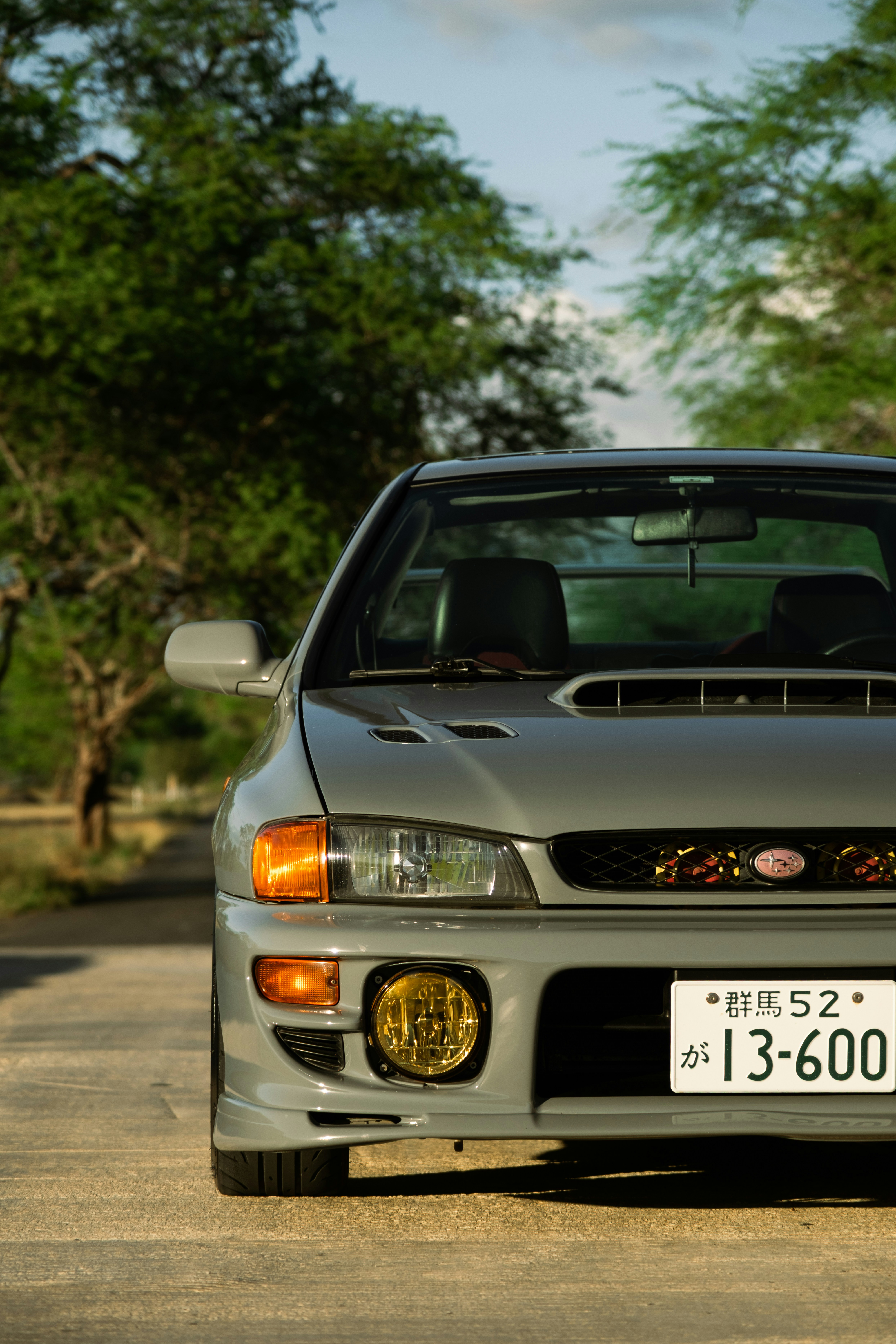 Front-Row Focus: The Silver Subaru Waiting in the Scenic Drive