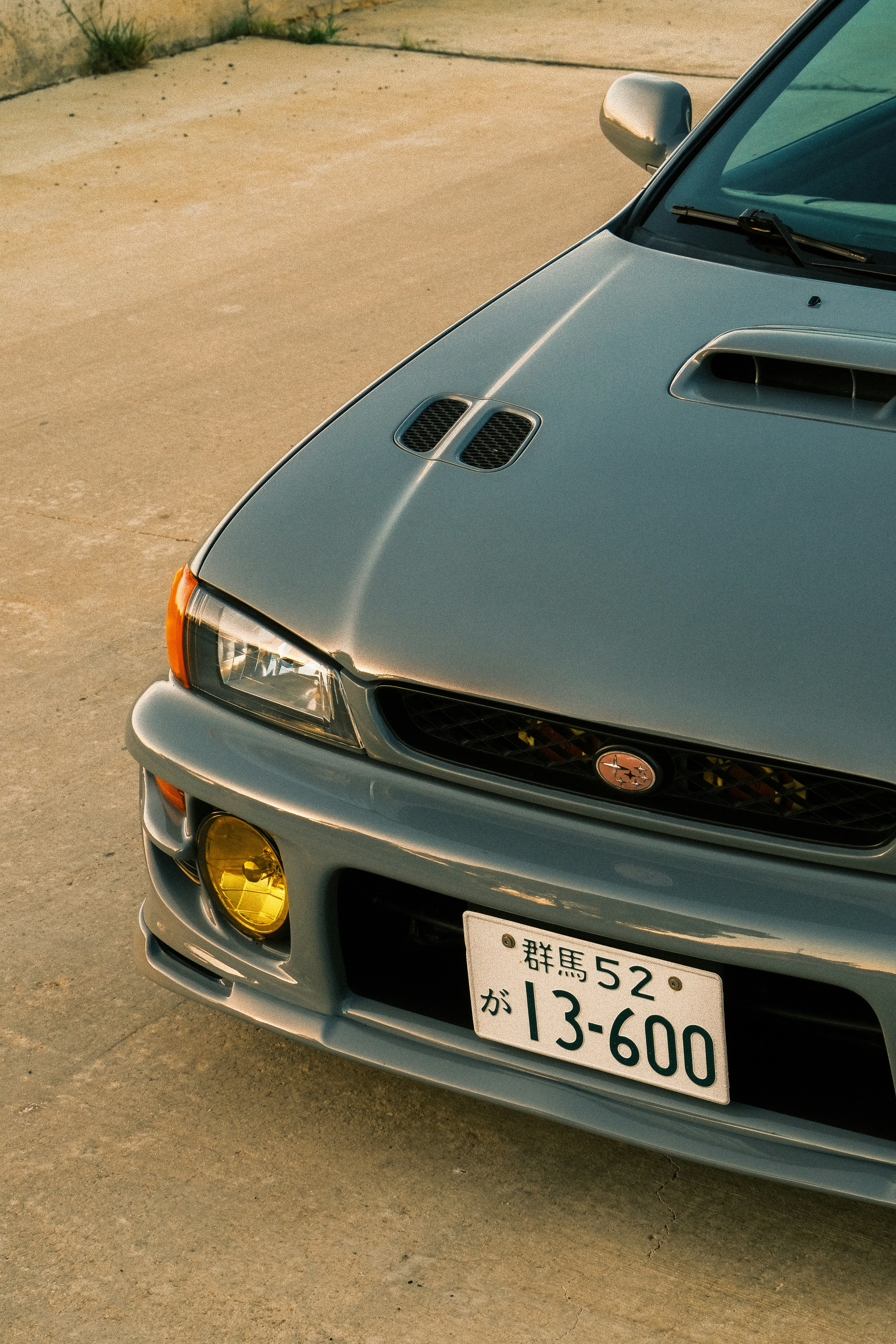 Blue-gray Impulse: A Front-Loaded Subaru with Japanese Plate Glare