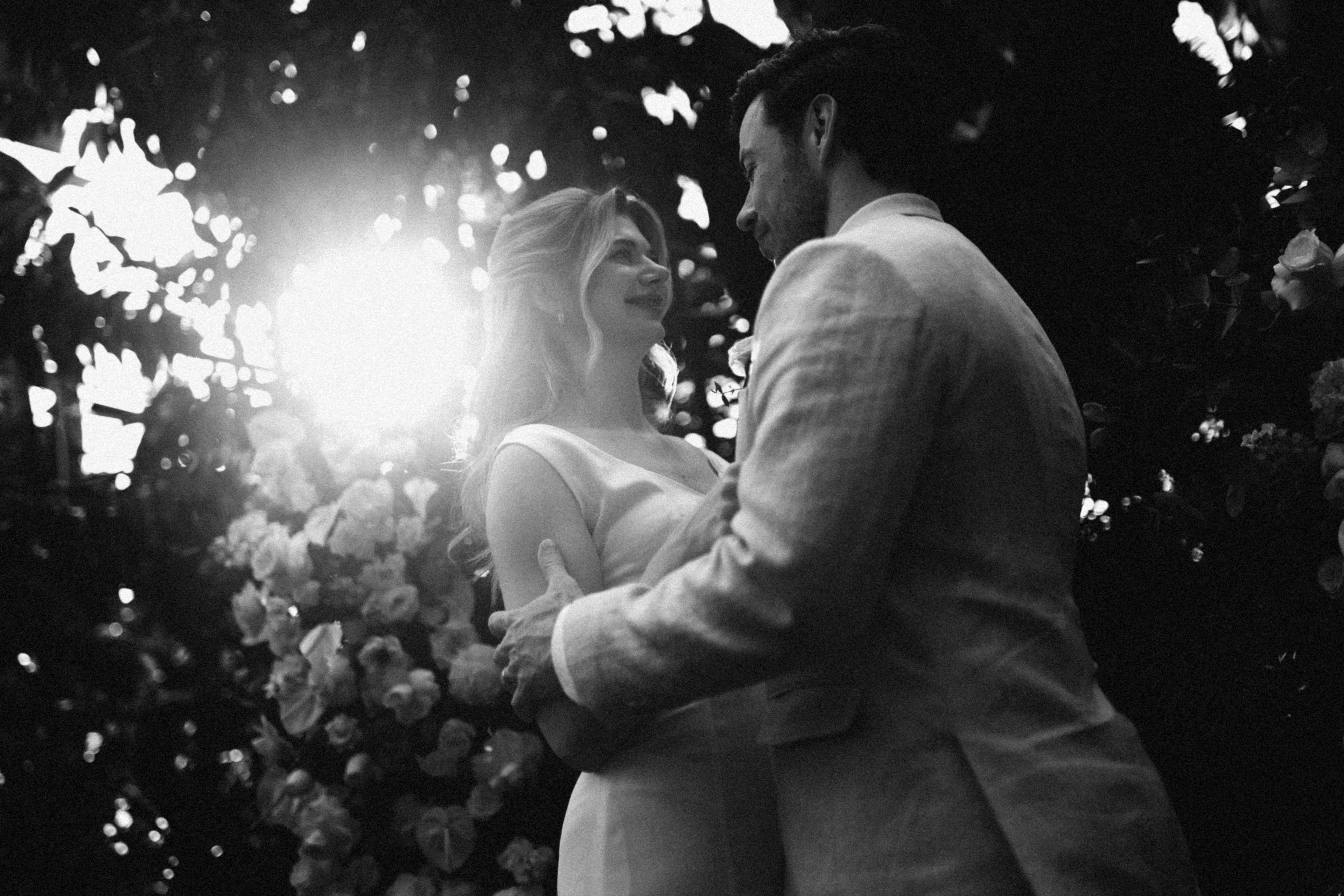 Moonlit Vows: A Tender Embrace Under Floral Arch