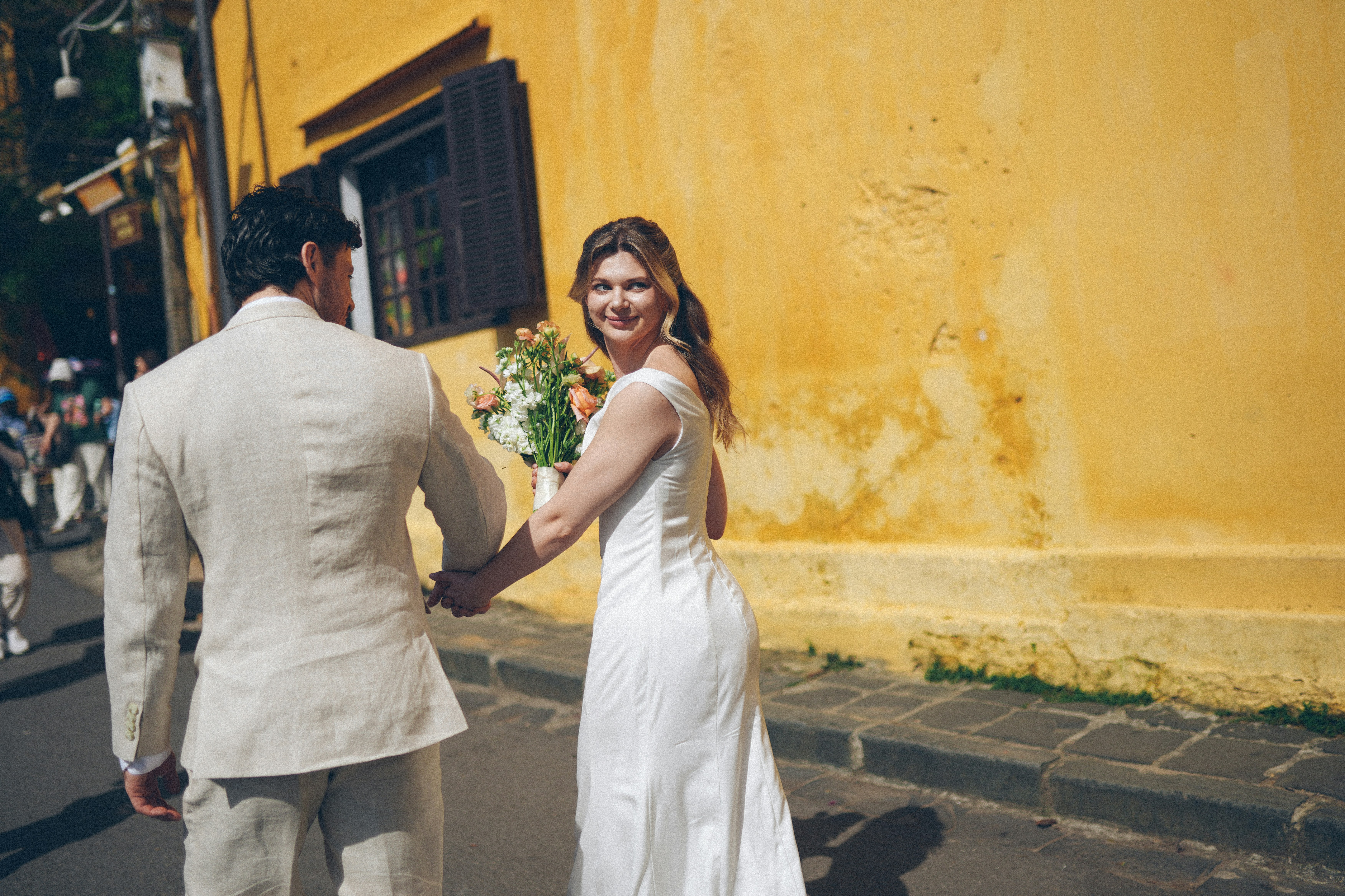 Golden Street Ceremony: A Bride Turns Toward the Cameraman